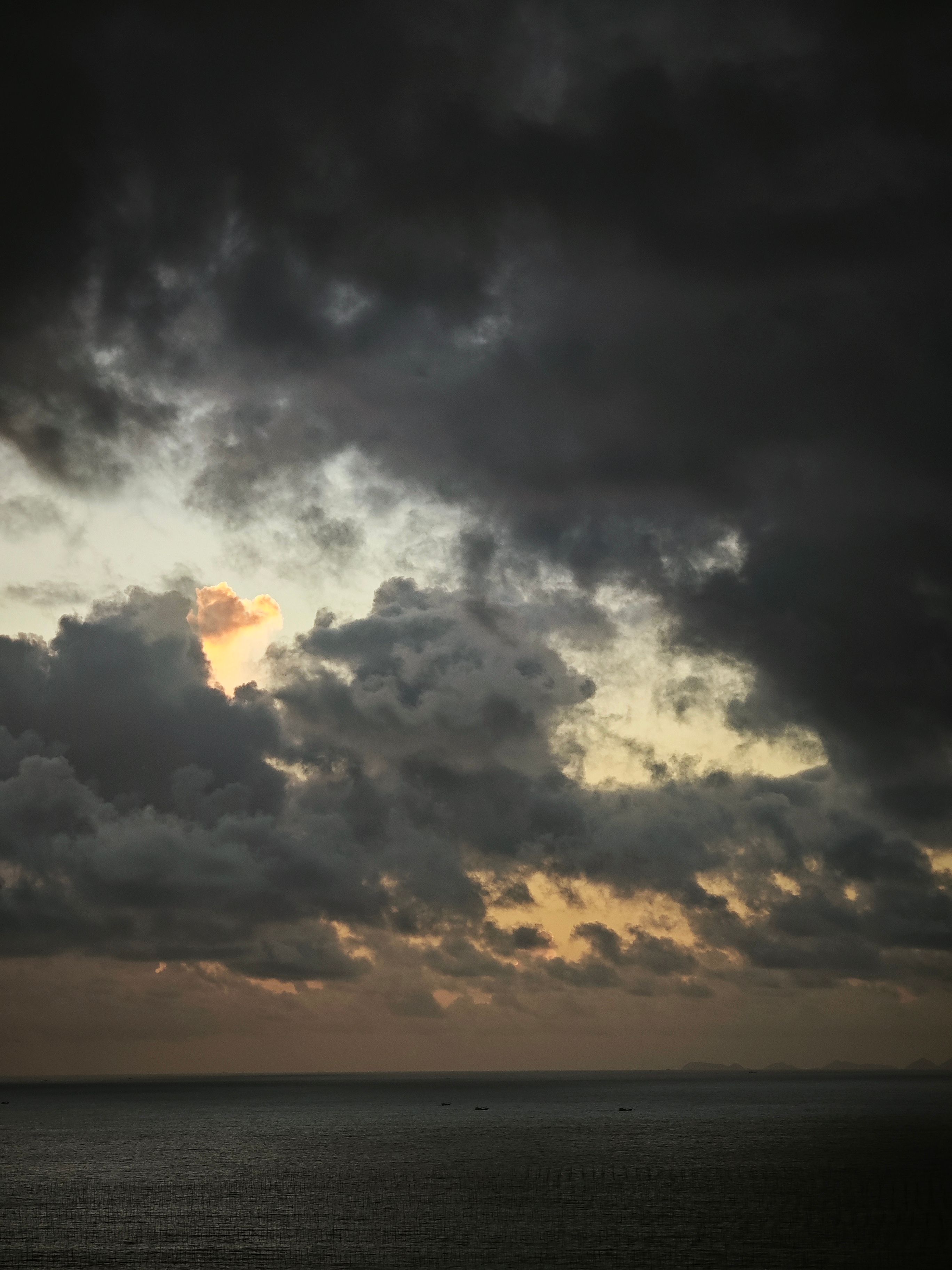 Dramatic Cloudy Sky Over a Calm Ocean Scene · Free Stock Photo