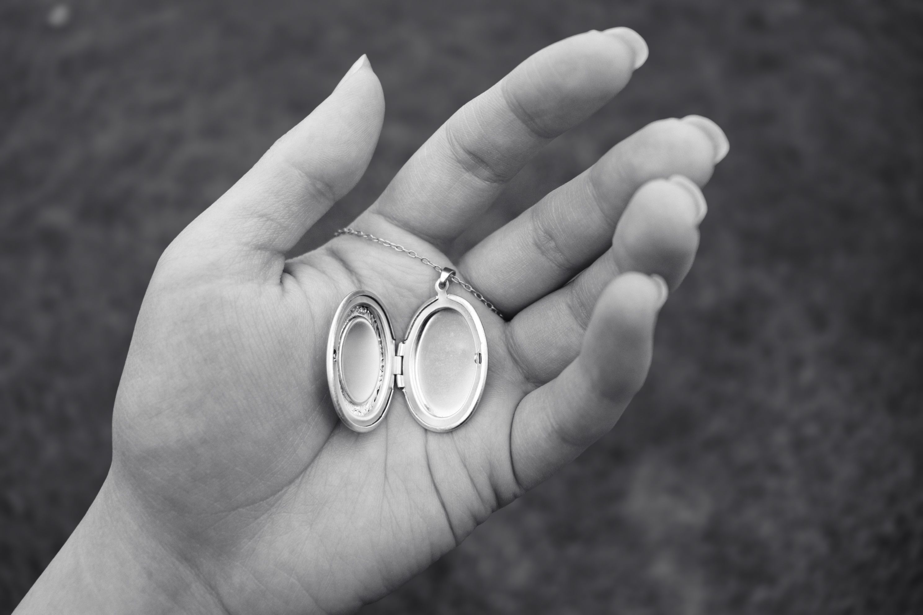 Black and White Hand Holding Open Locket · Free Stock Photo