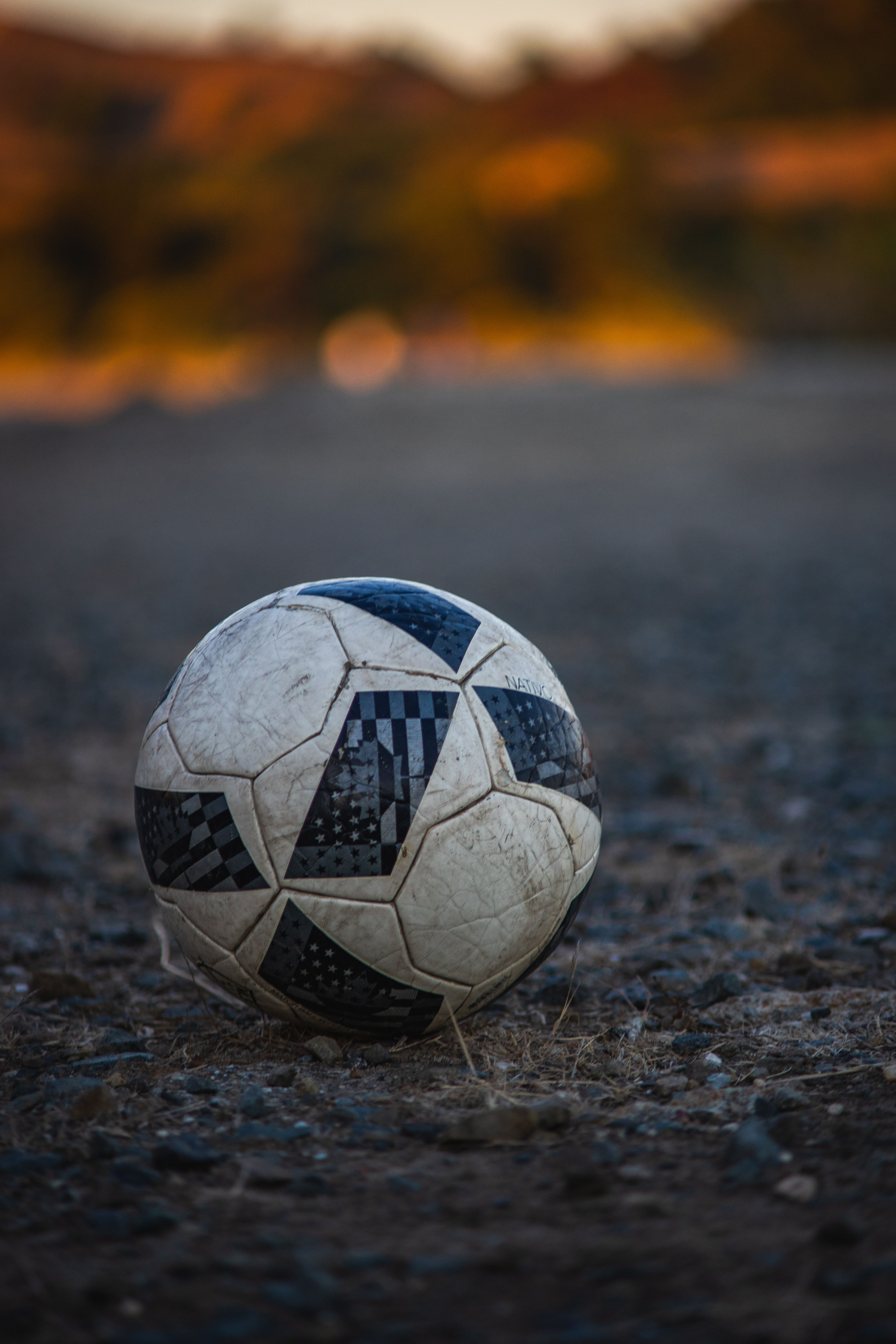 Rustic Soccer Ball on Gravel Field · Free Stock Photo