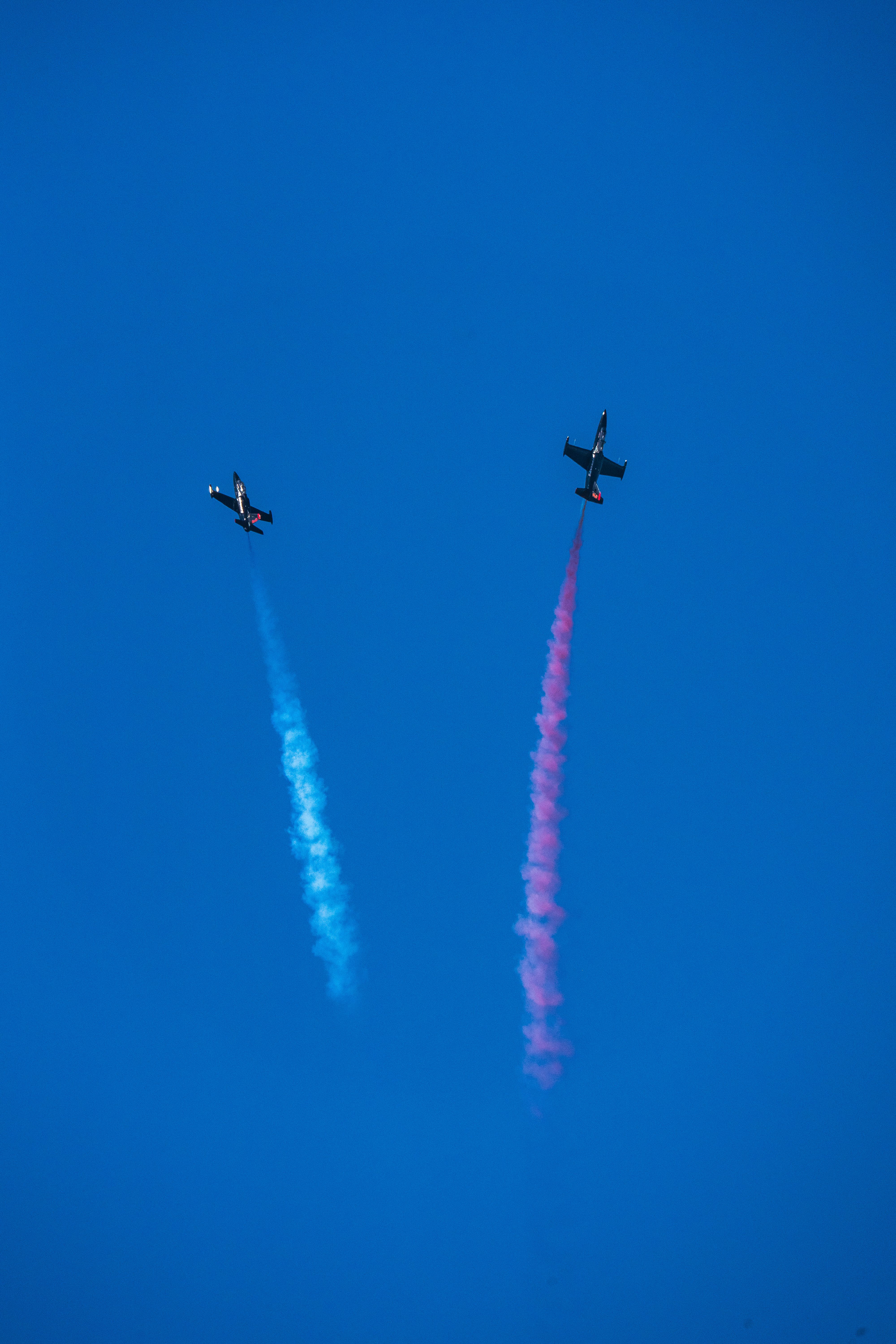 Aerobatic Aircraft with Colorful Smoke Trails · Free Stock Photo