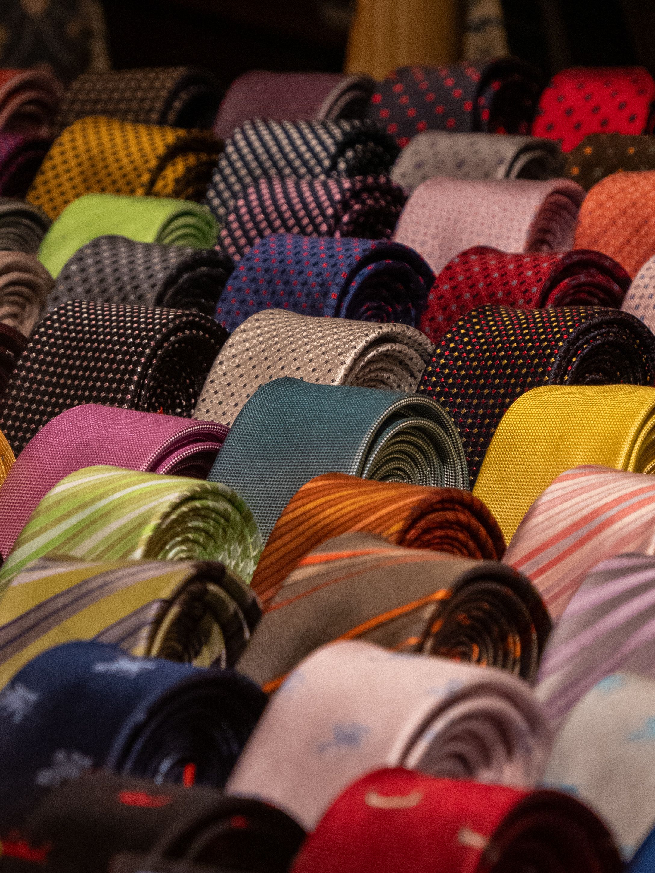 Vibrant Display of Multicolored Rolled Ties · Free Stock Photo