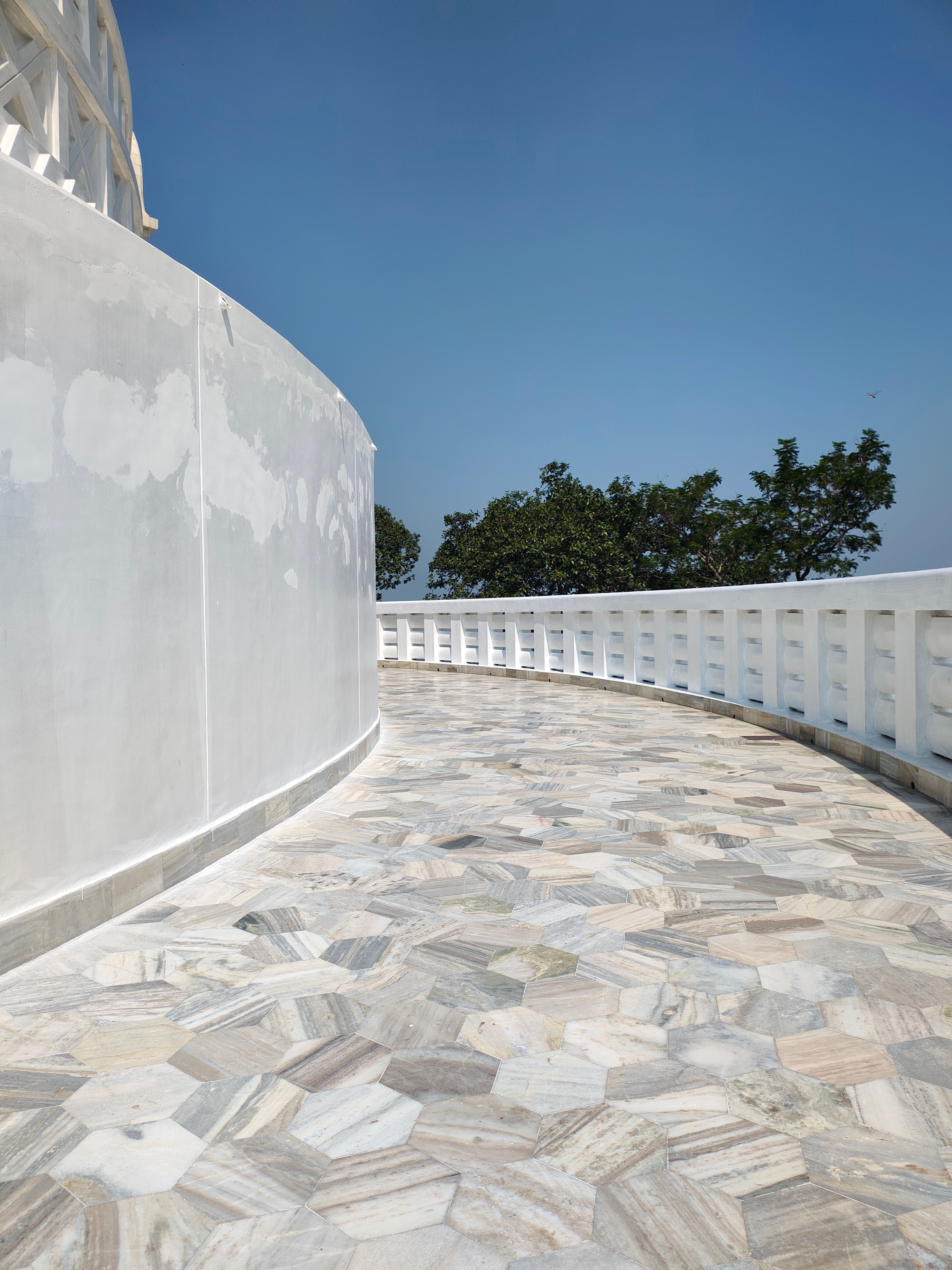 Curved Marble Pathway with Blue Sky View · Free Stock Photo