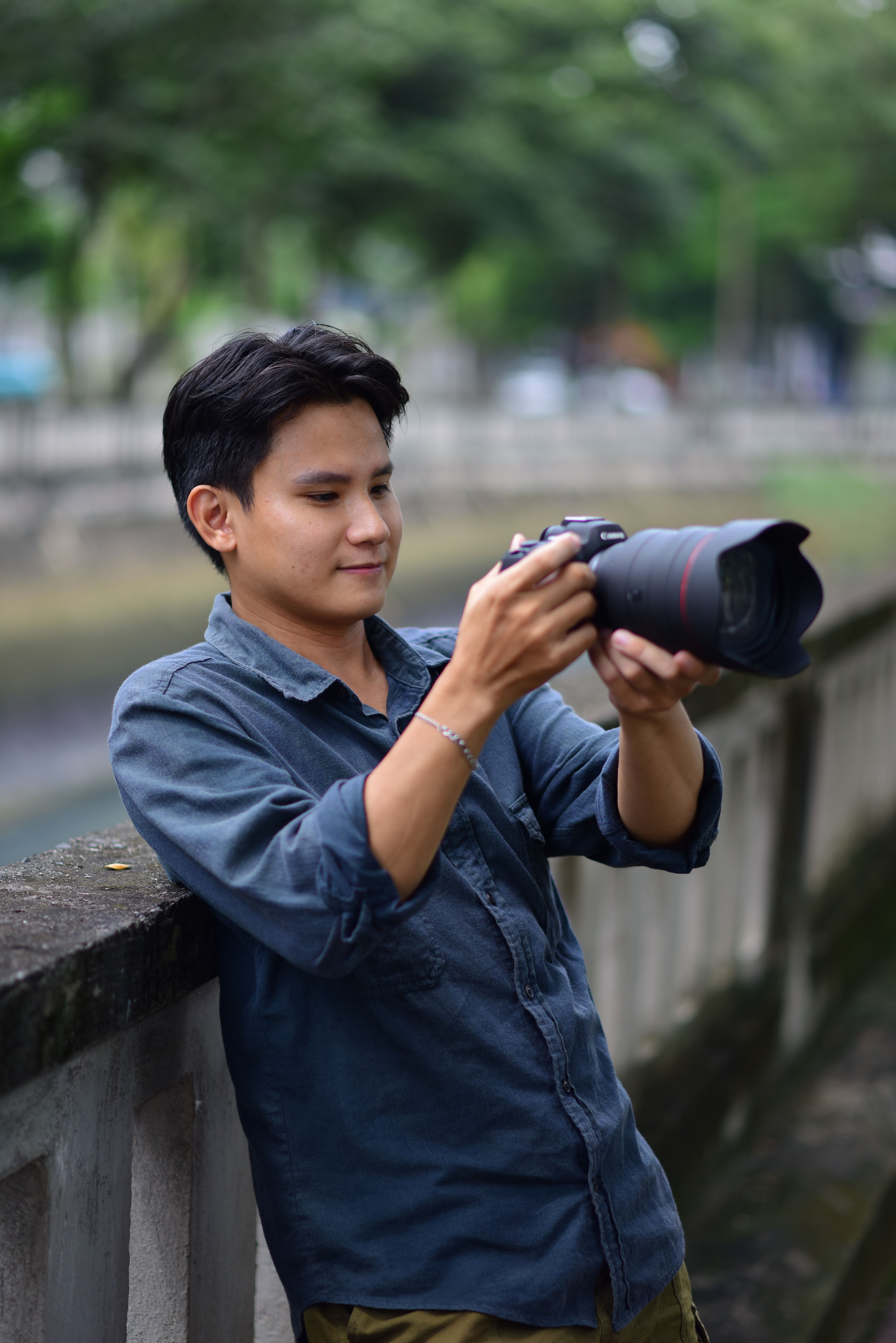 Young Photographer Capturing Outdoors Image · Free Stock Photo