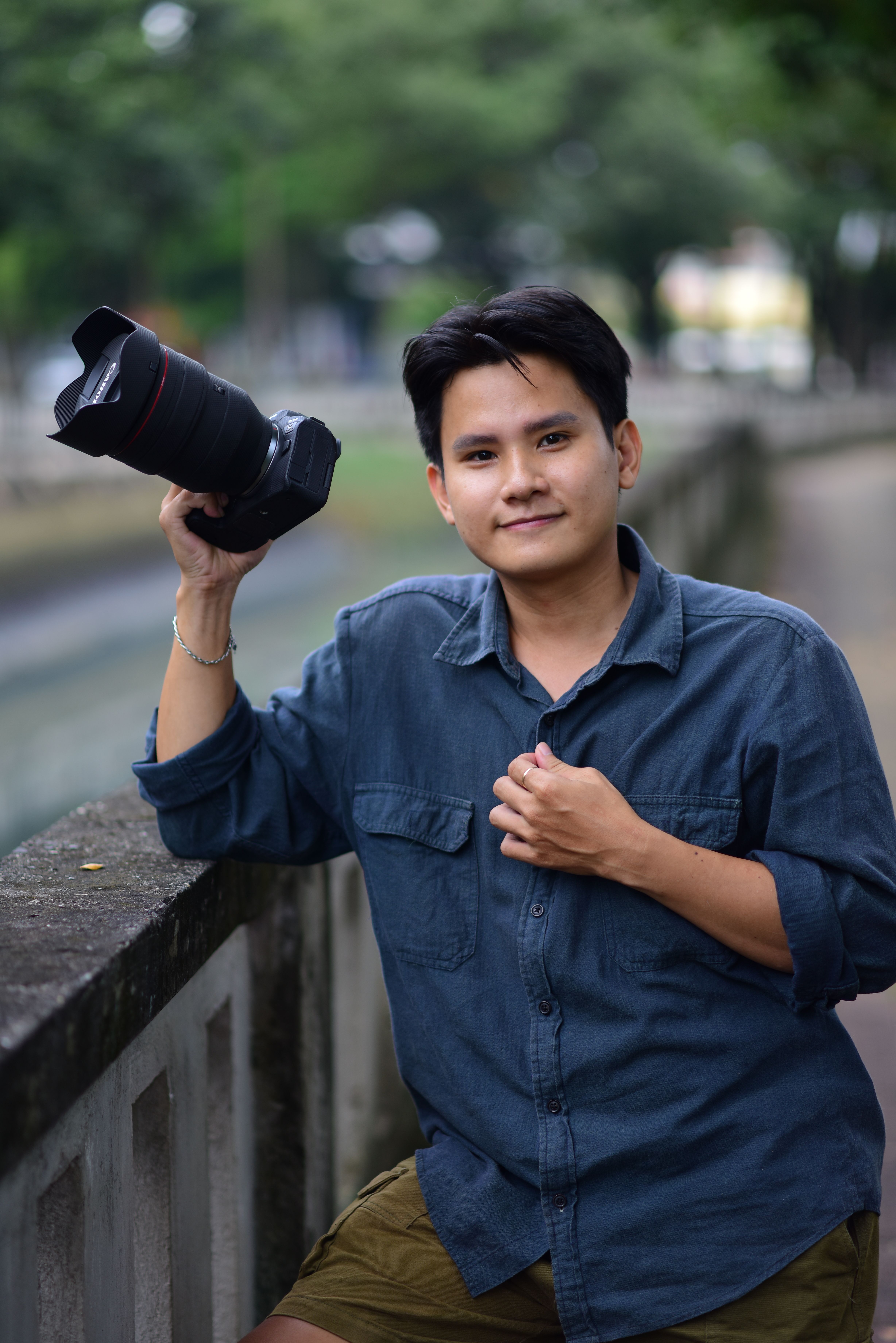 Young Photographer Outdoors with Camera · Free Stock Photo