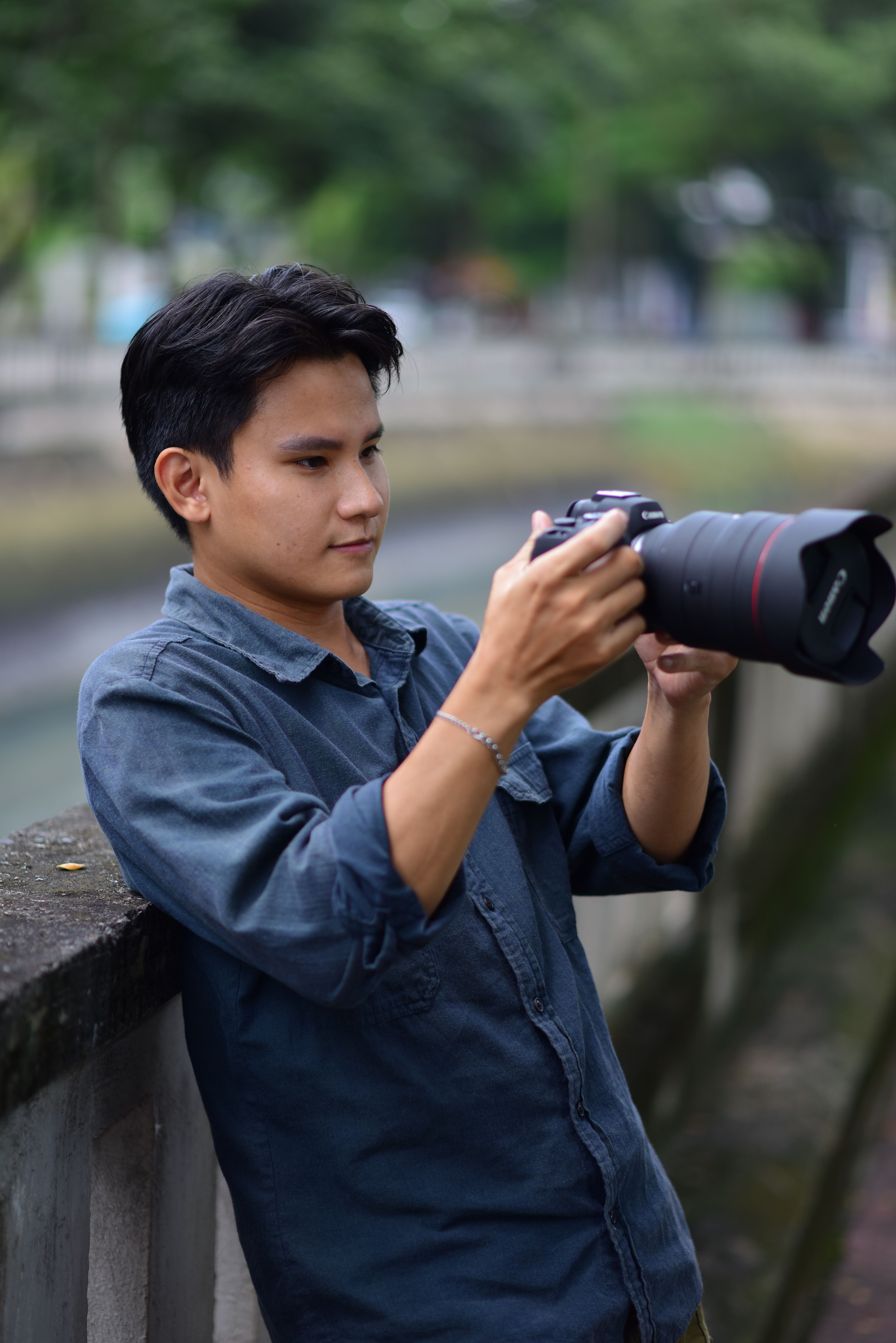 Young Photographer Capturing Urban Scenes Outdoors · Free Stock Photo