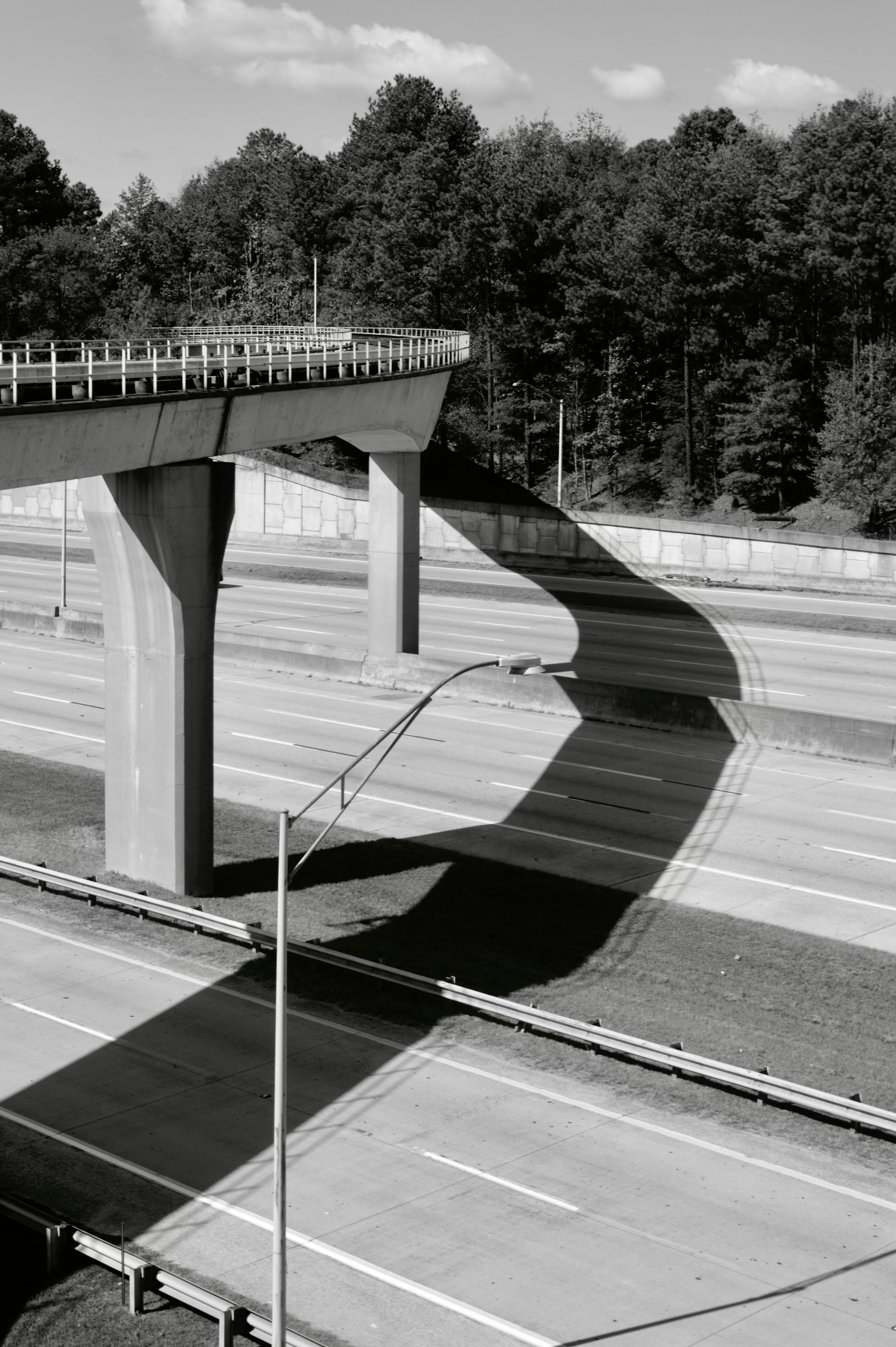 Black and White Overpass Shadow on Quiet Highway · Free Stock Photo