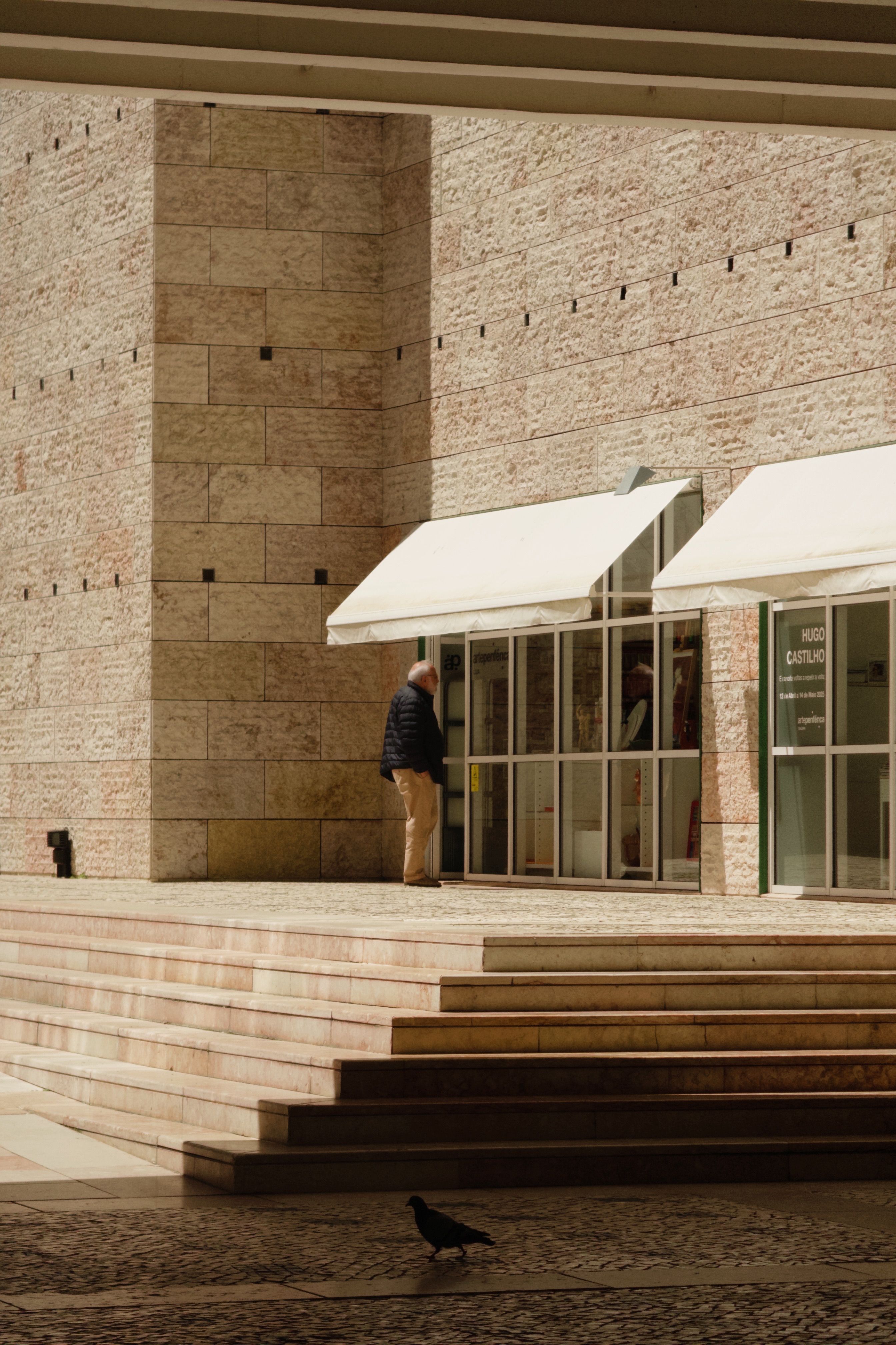 Man Entering Modern Brick Building Entrance · Free Stock Photo