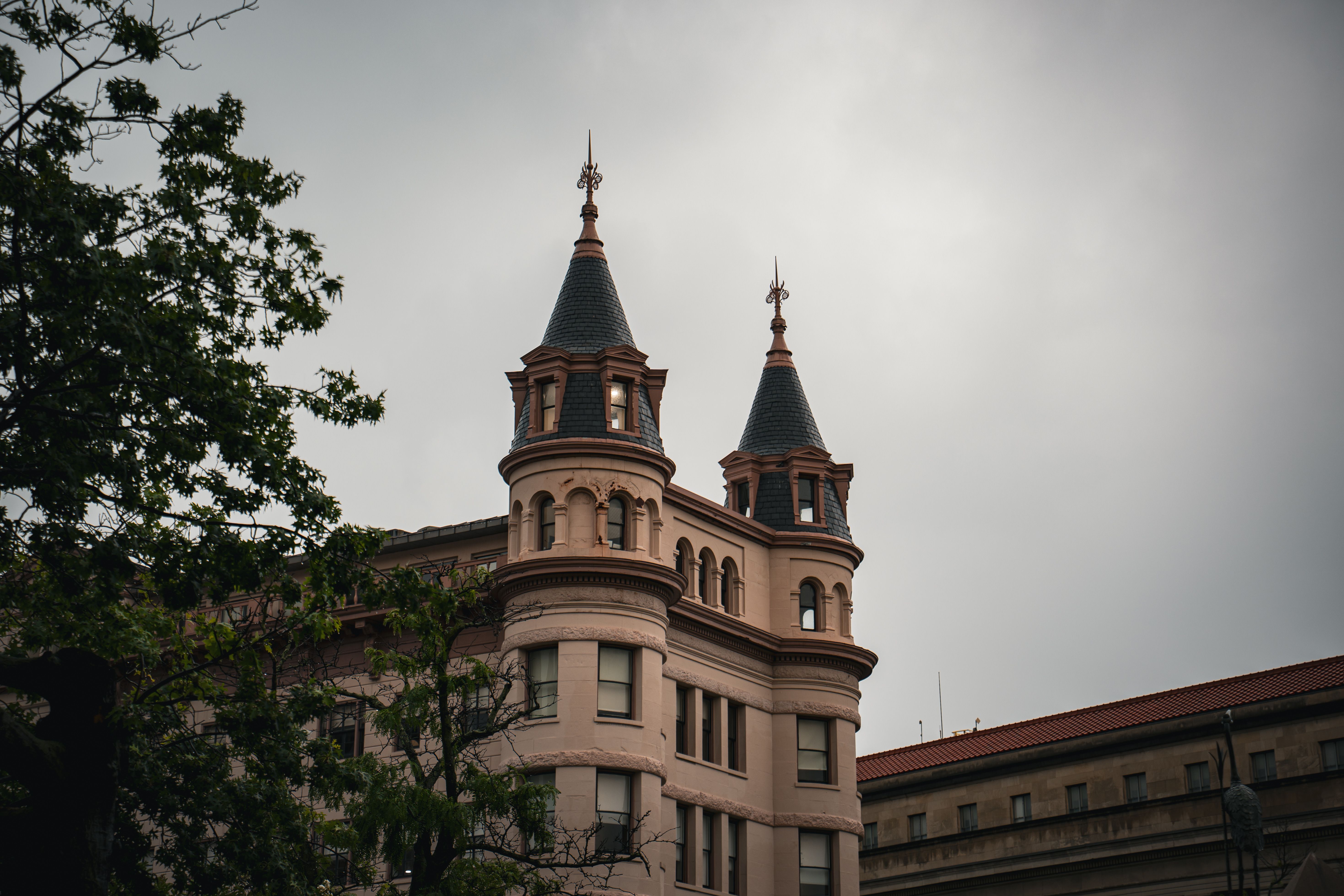 Historic Building with Towers in Overcast Sky · Free Stock Photo