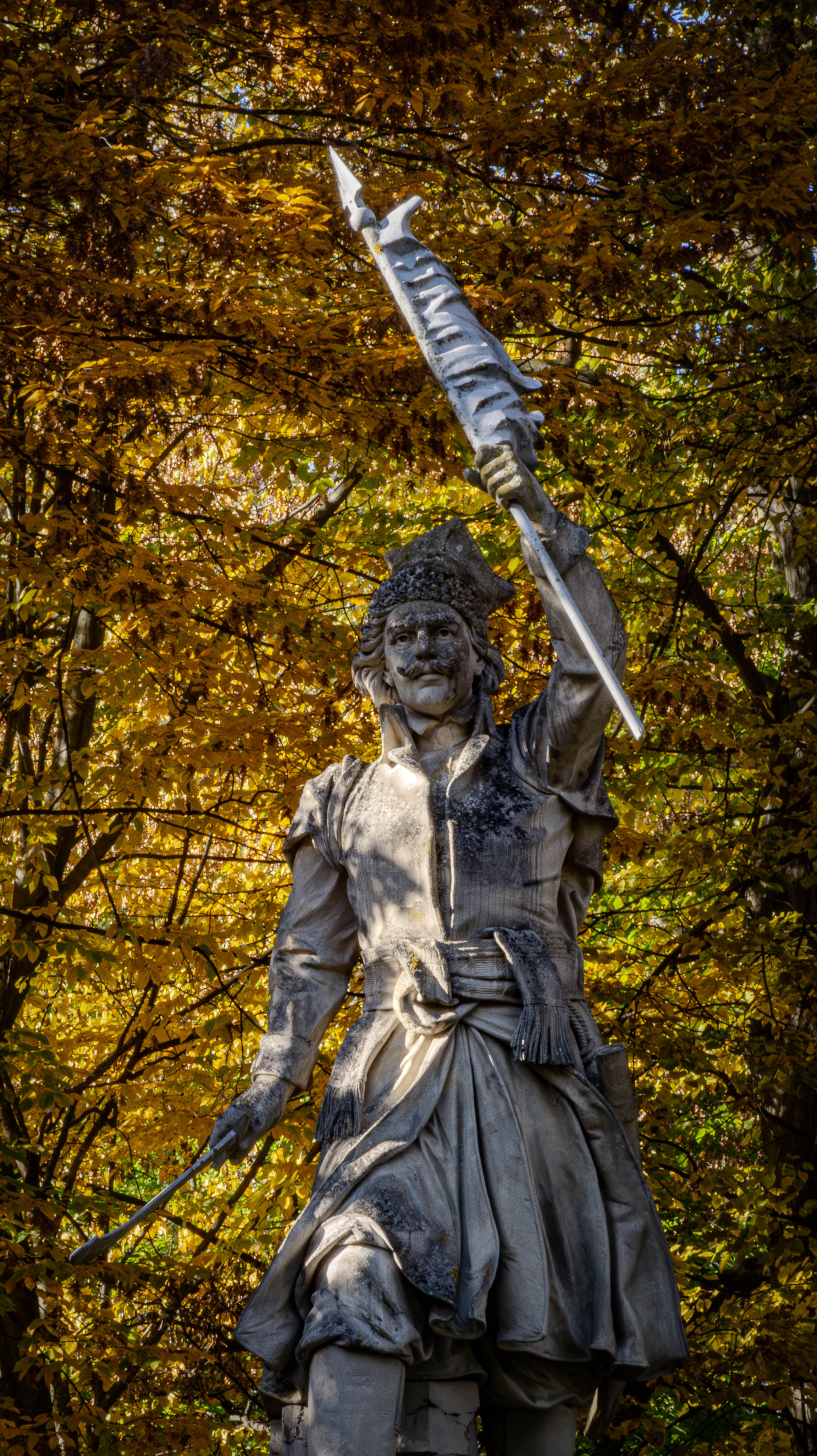Statue Amidst Autumn Foliage in Lviv · Free Stock Photo