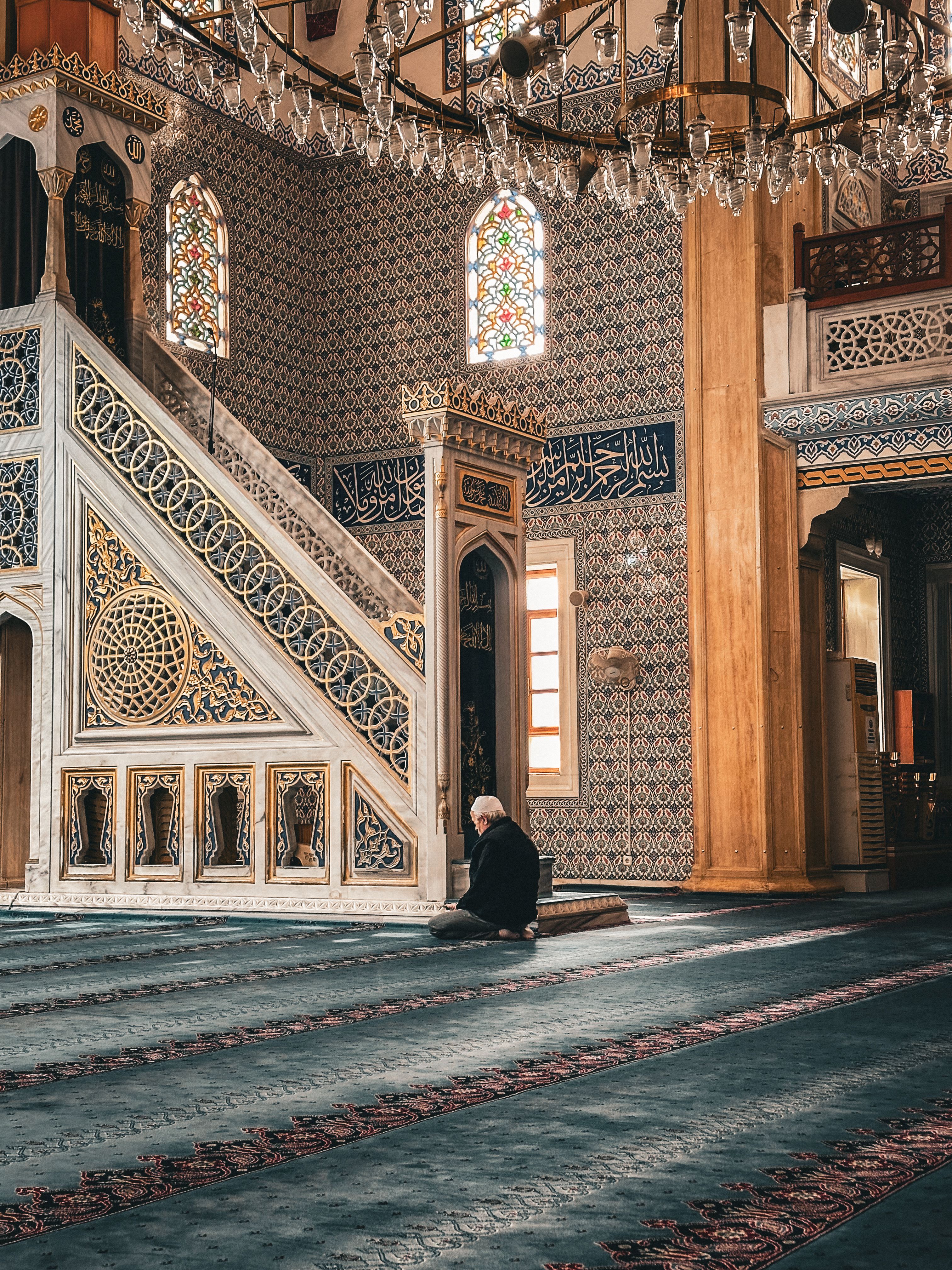 Man Praying Inside an Ornate Mosque Interior · Free Stock Photo
