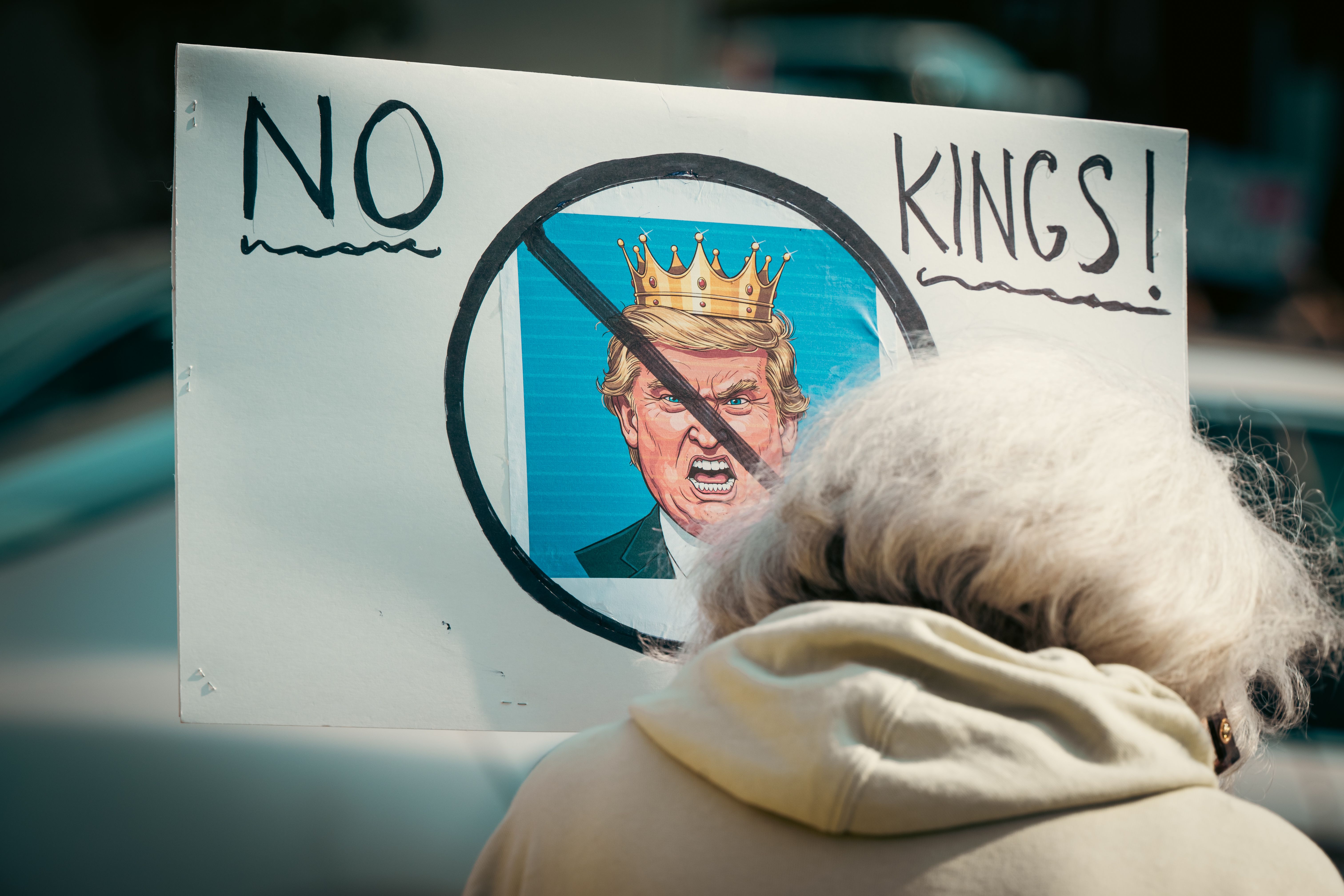 Protest Sign Against Monarchy and Political Figure · Free Stock Photo