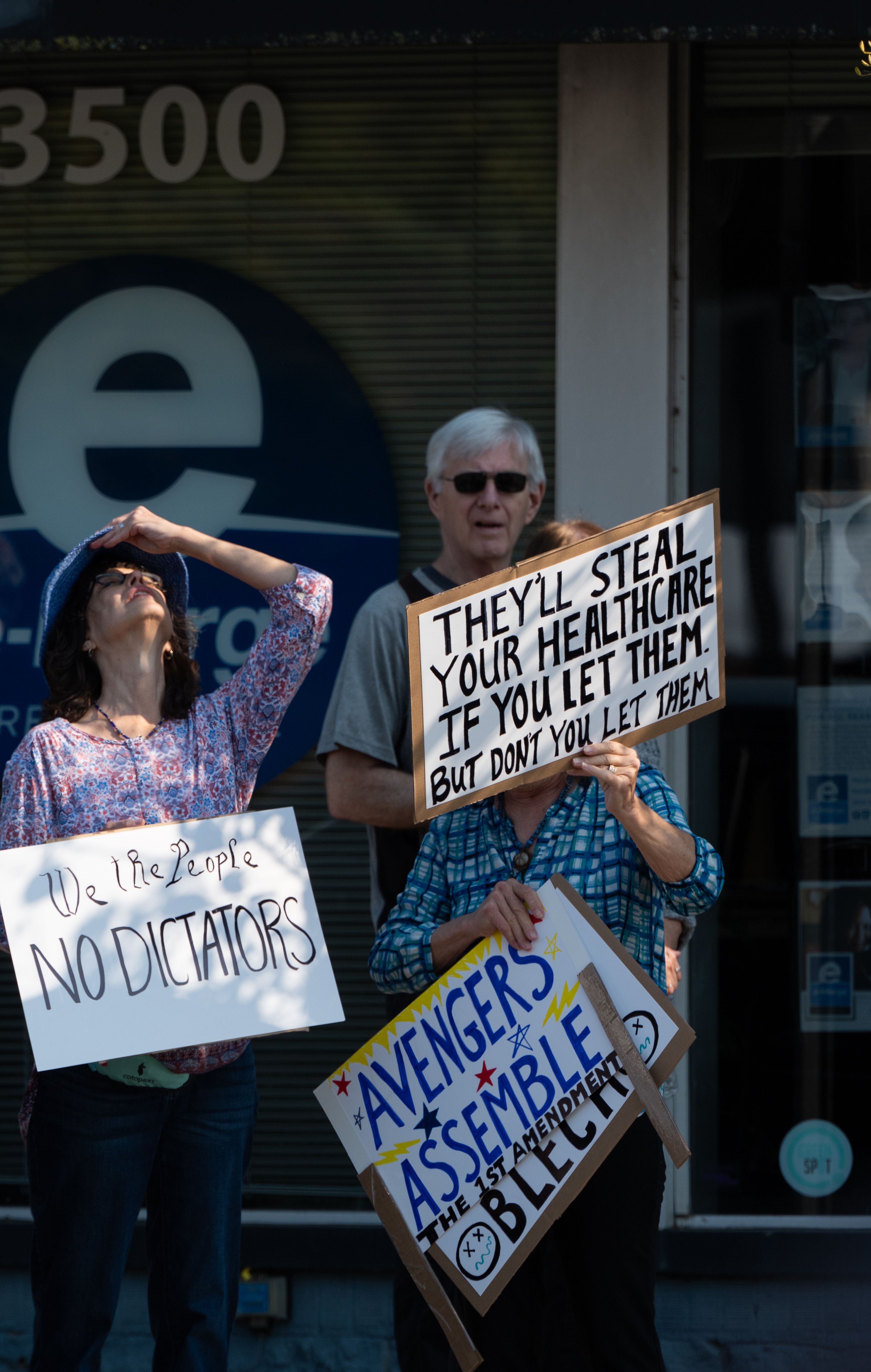 Protesters Holding Signs in Urban Setting · Free Stock Photo