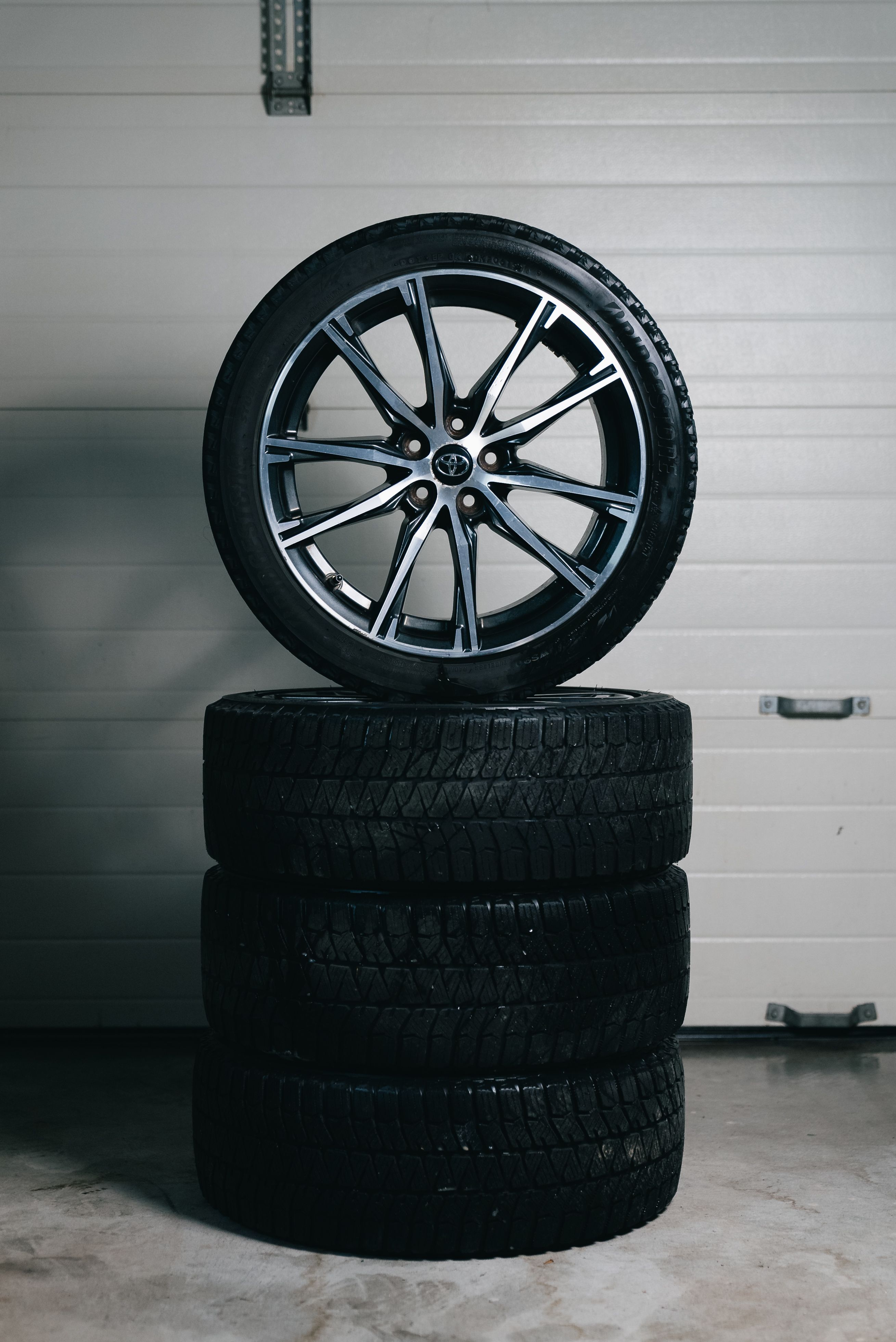 Stack of Car Tires with Alloy Wheel Indoors · Free Stock Photo