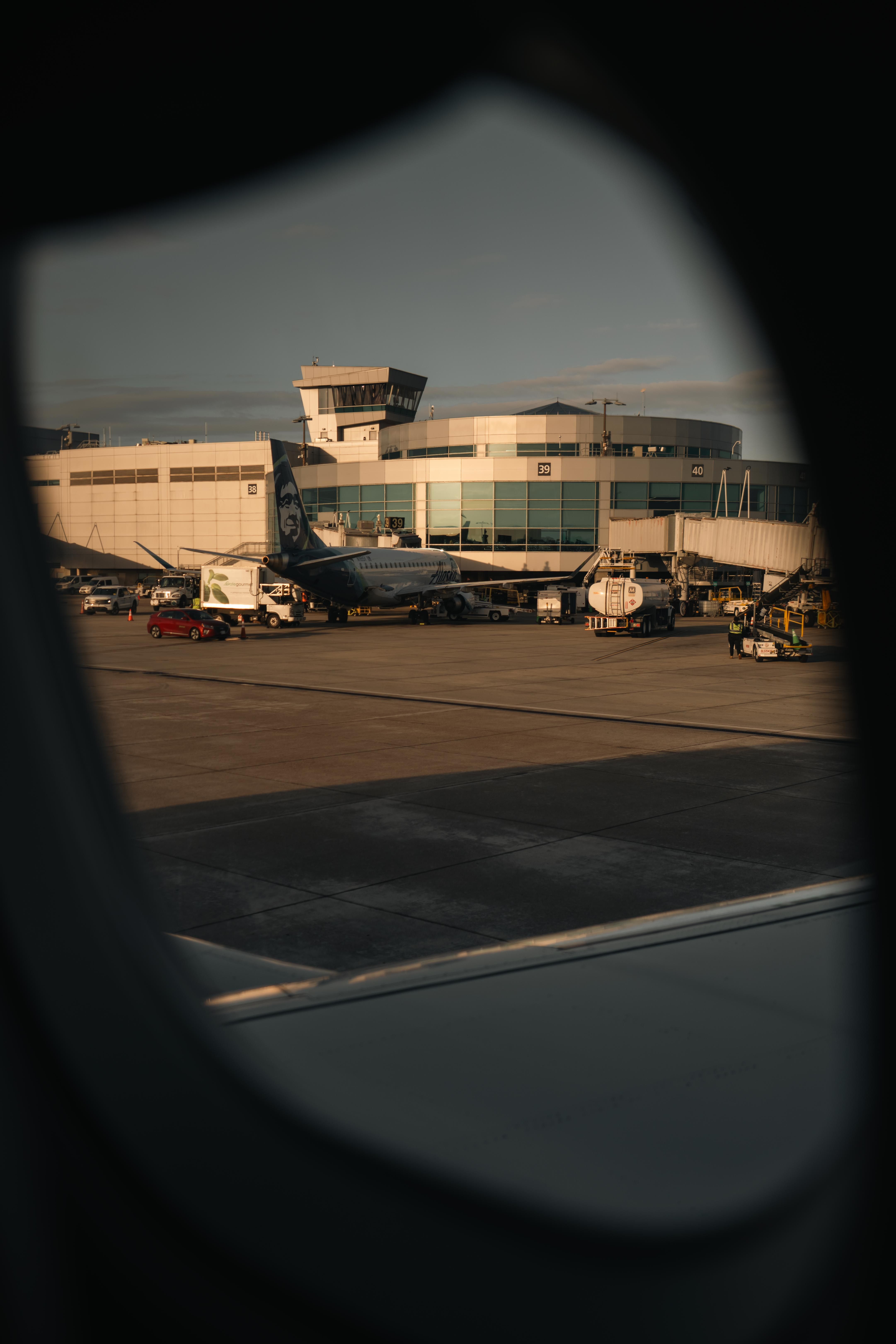 View of Airport Terminal through Airplane Window · Free Stock Photo