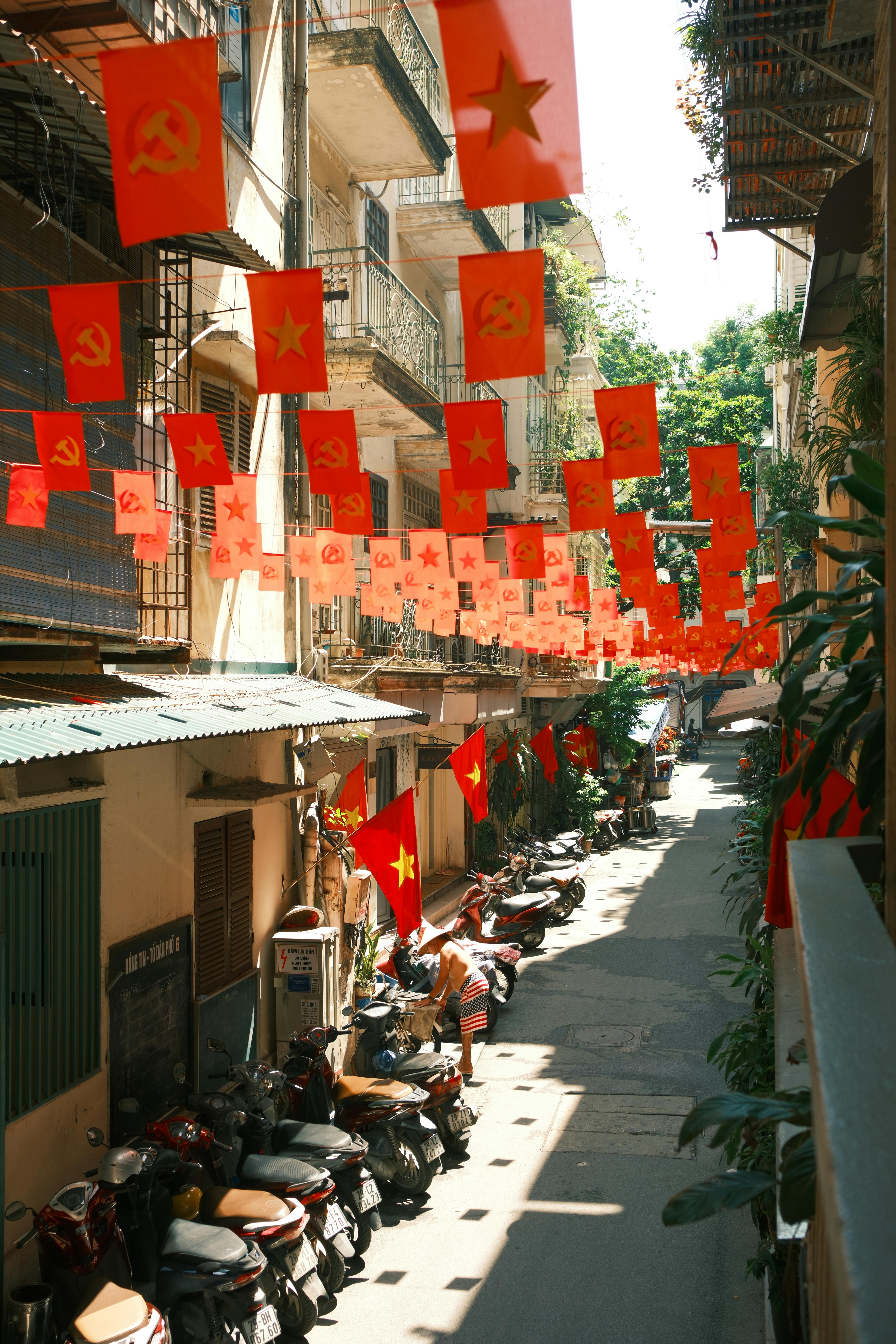 Street with Red Flags and Motorbikes in Hanoi · Free Stock Photo