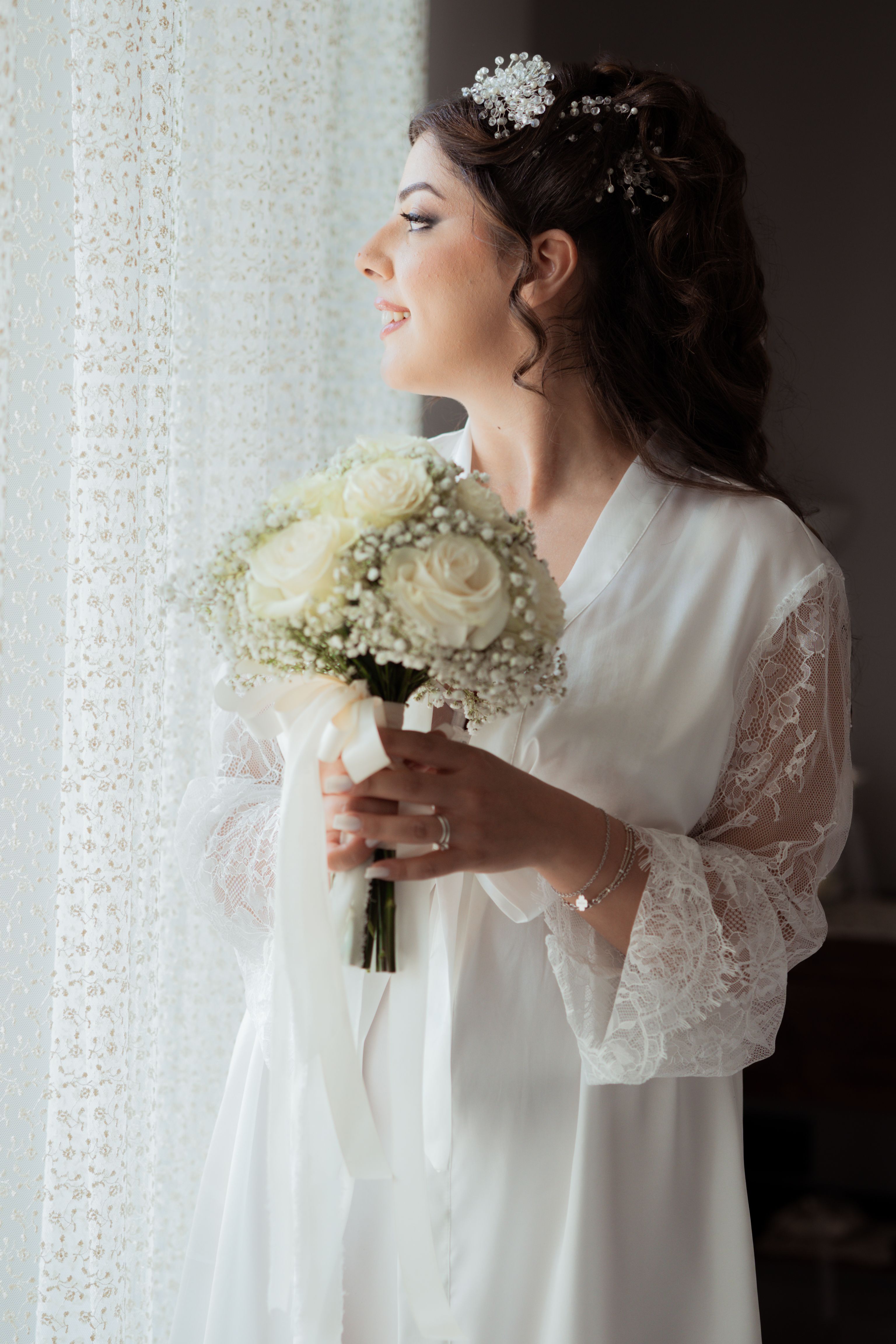 Elegant Bride Holding Bouquet Looking Out Window · Free Stock Photo