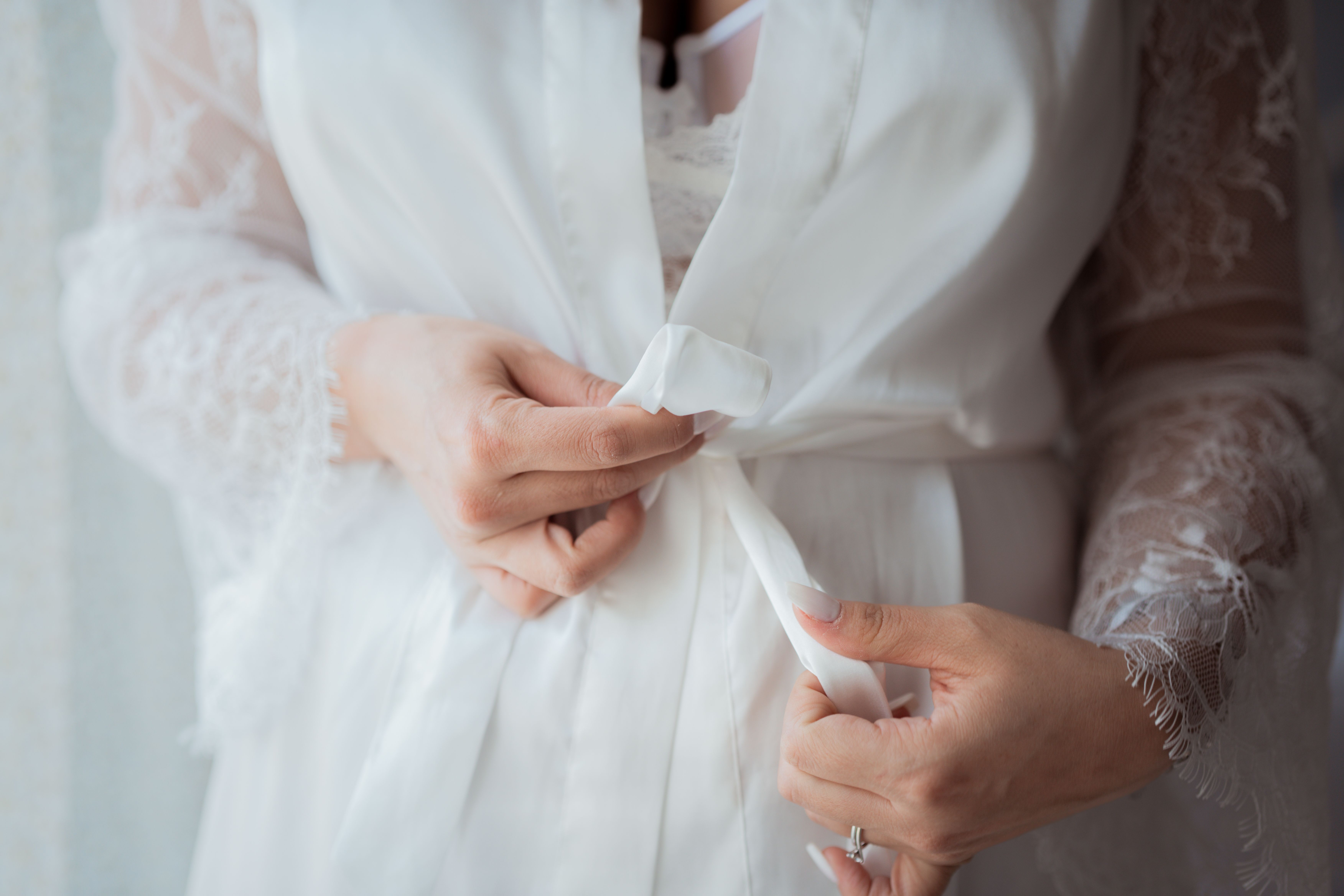 Woman Tying Belt on Elegant White Robe · Free Stock Photo