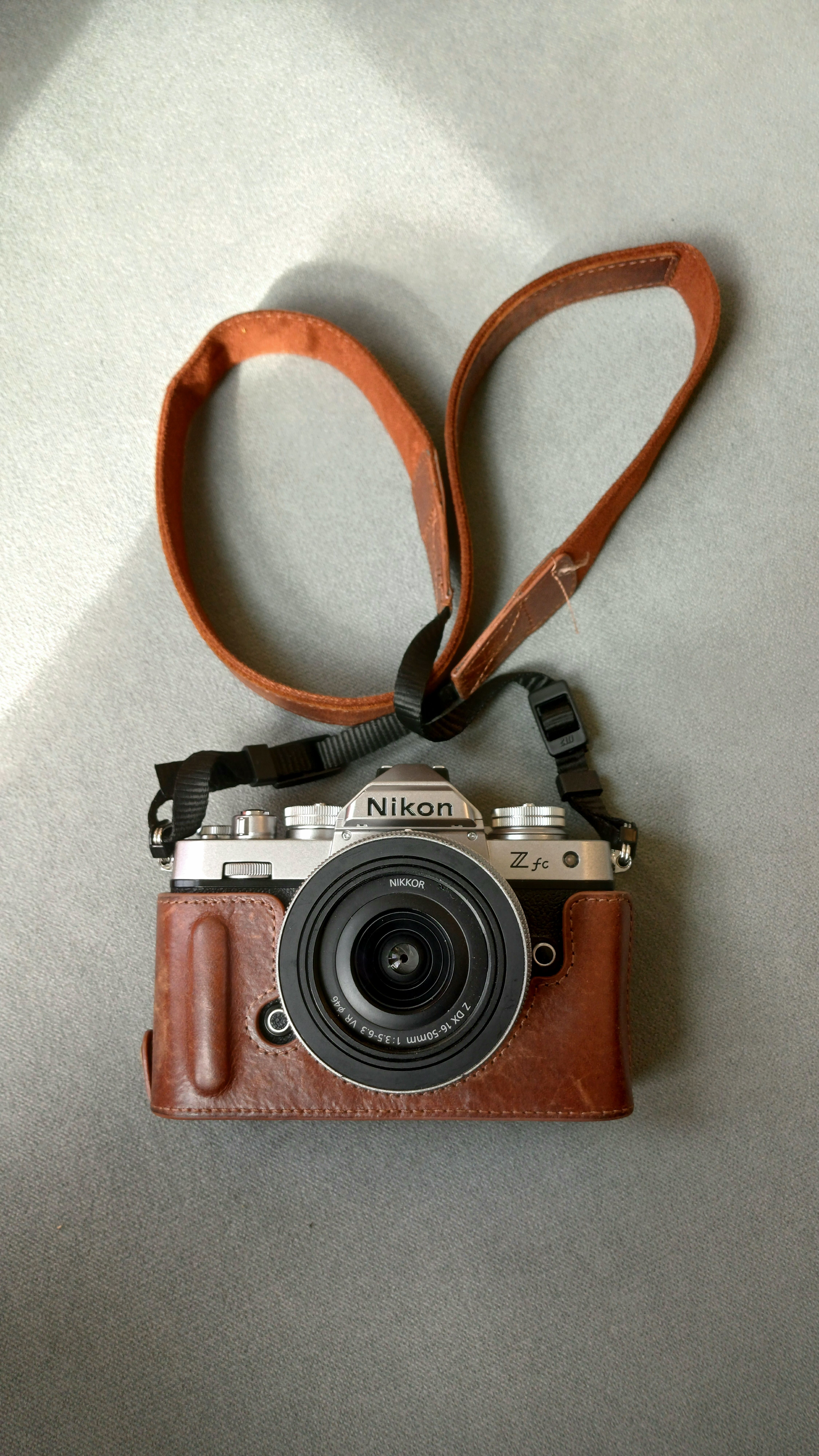 Vintage Nikon Camera with Leather Case on Display · Free Stock Photo