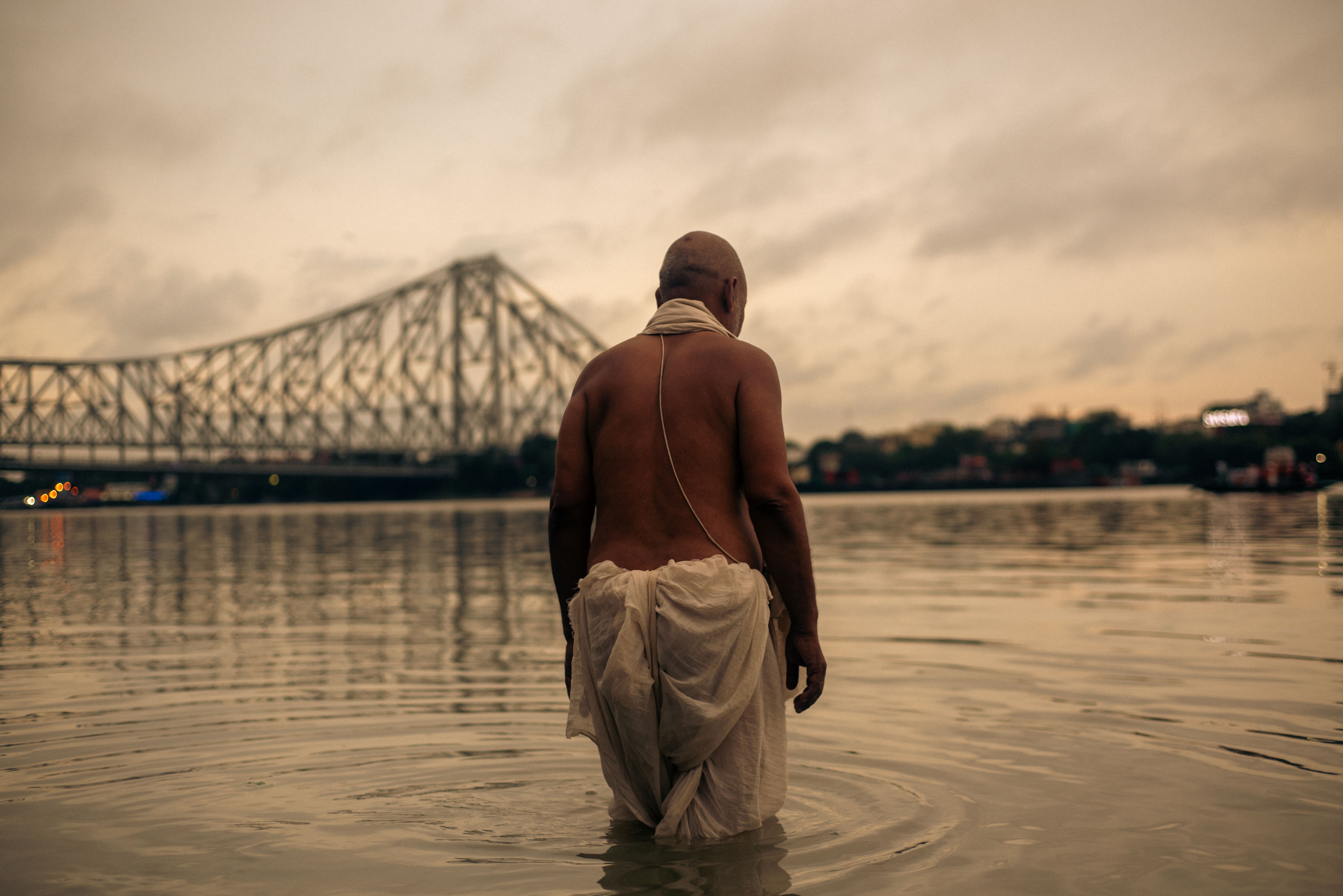 Man Wades in River by Iconic Howrah Bridge · Free Stock Photo