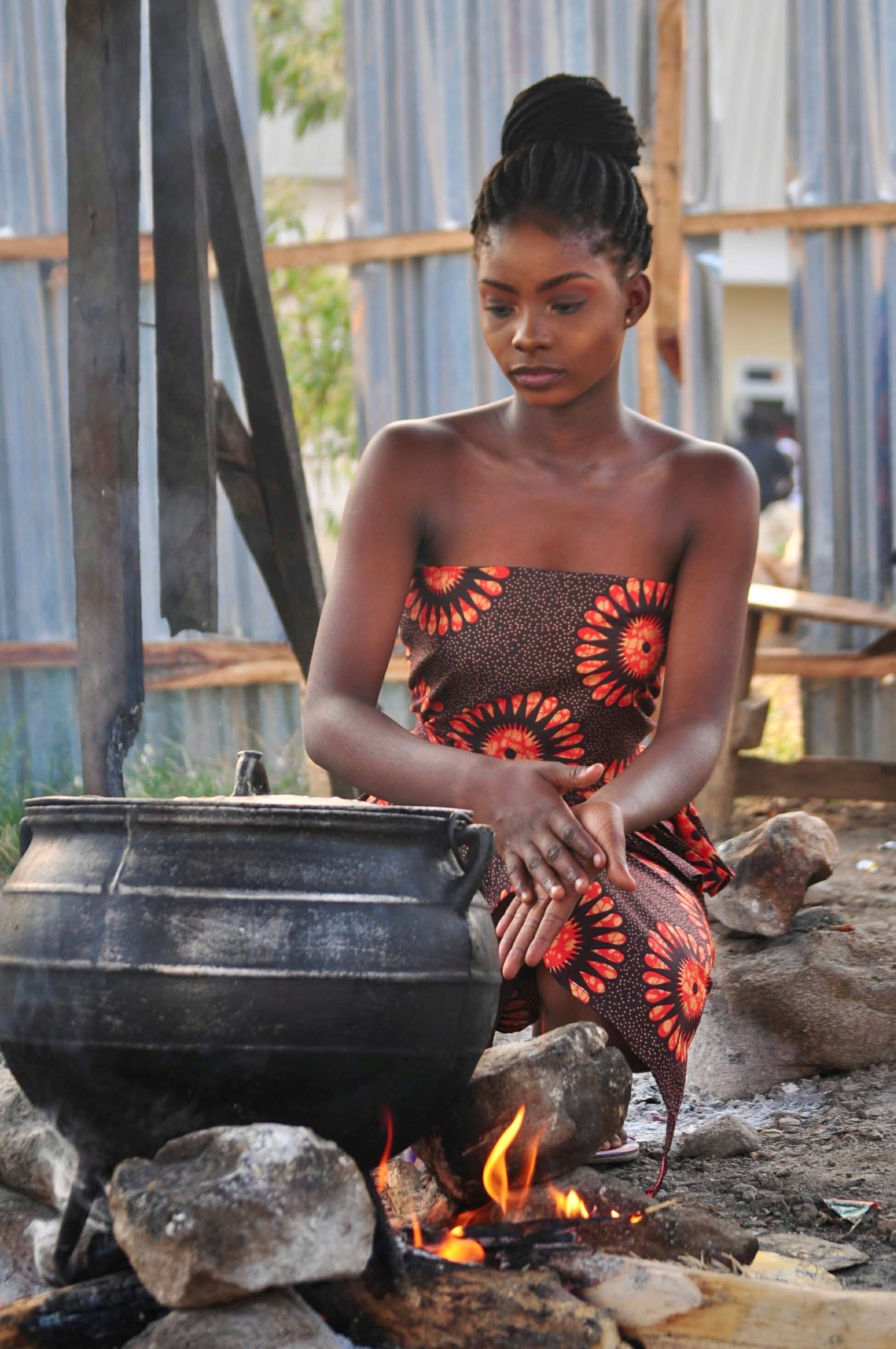African Woman Cooking Outdoors in Nigeria · Free Stock Photo