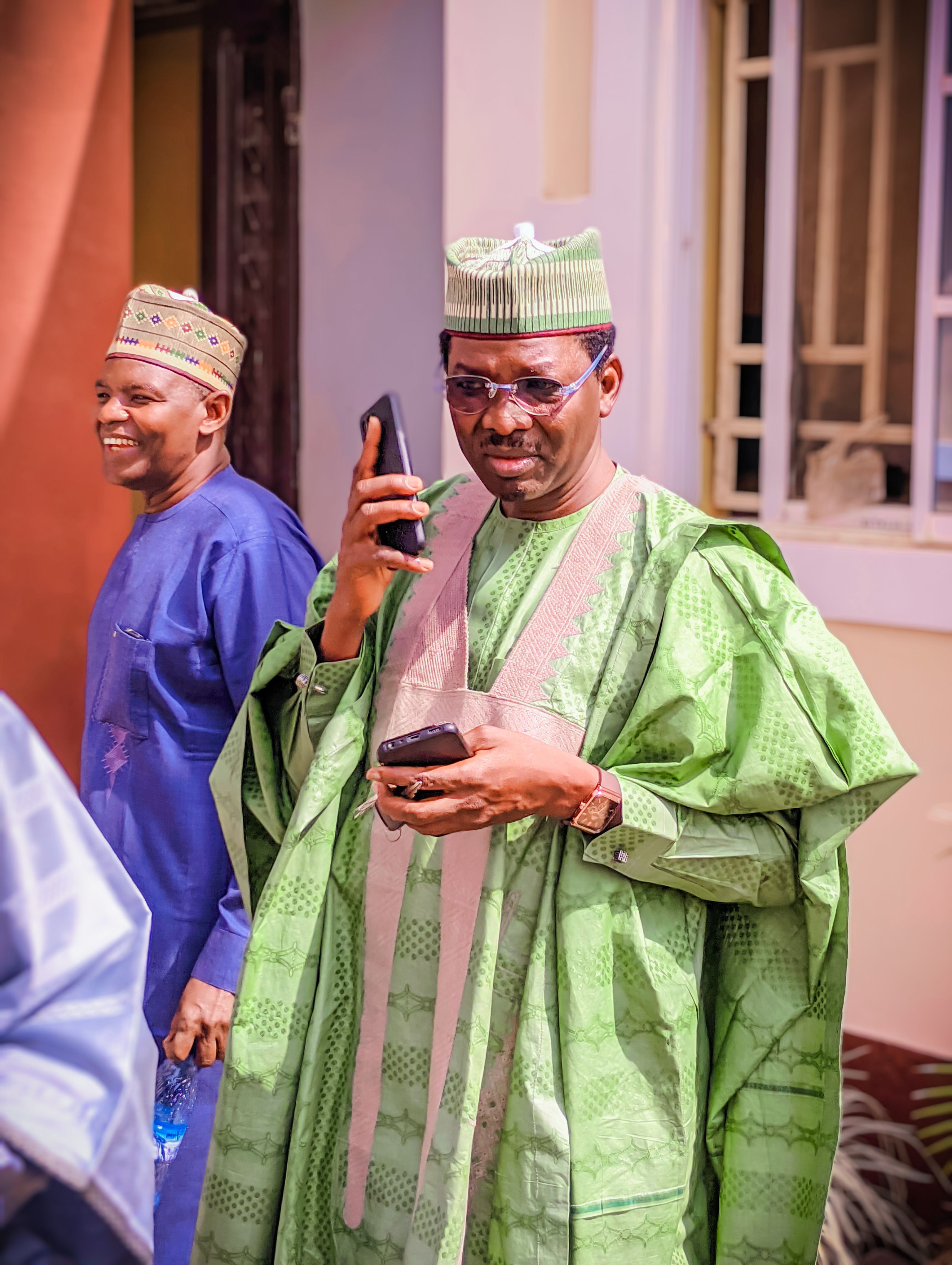 Men in Traditional Nigerian Attire Using Phones · Free Stock Photo