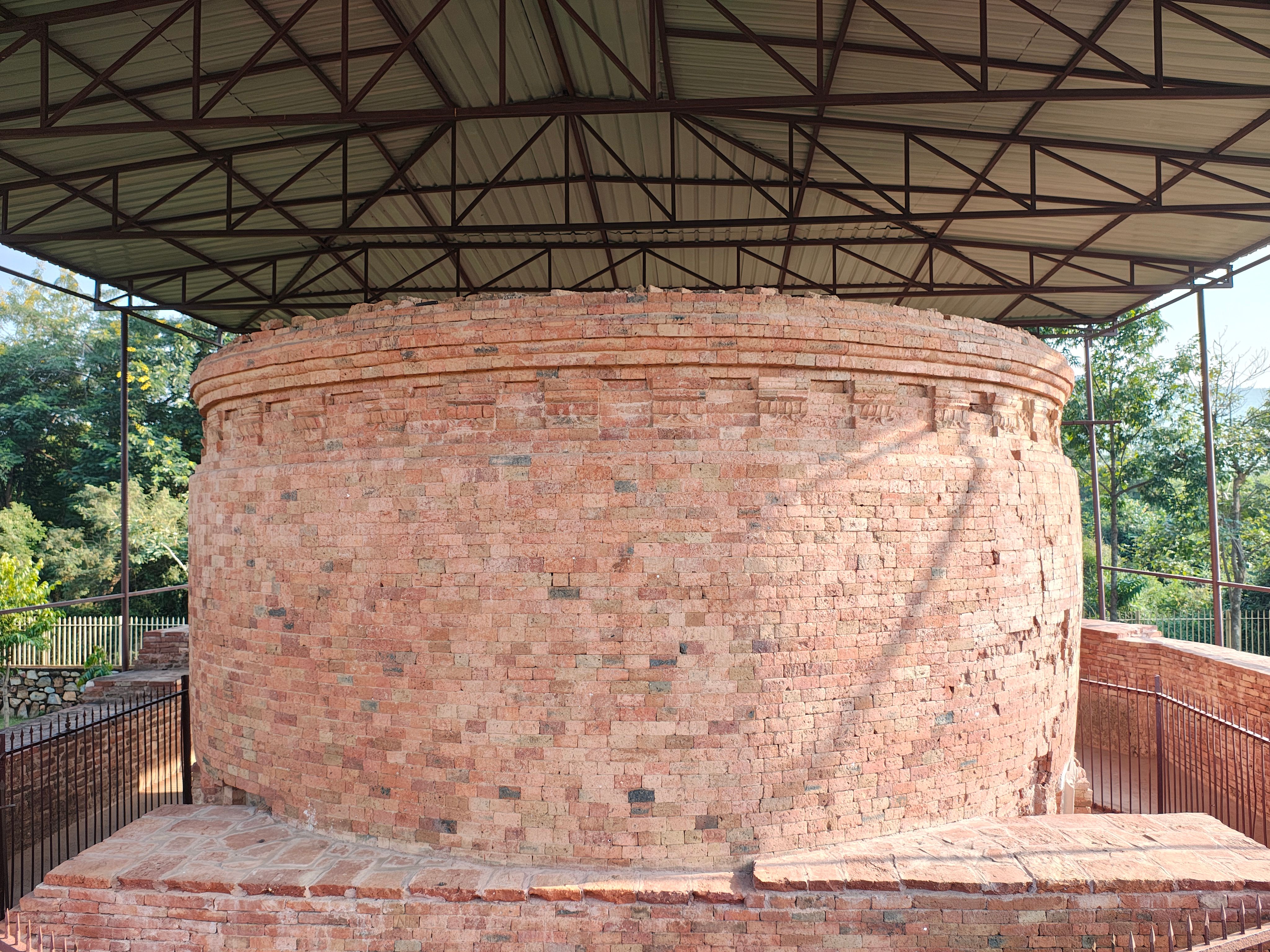 Ancient Brick Structure Under Metal Roof · Free Stock Photo