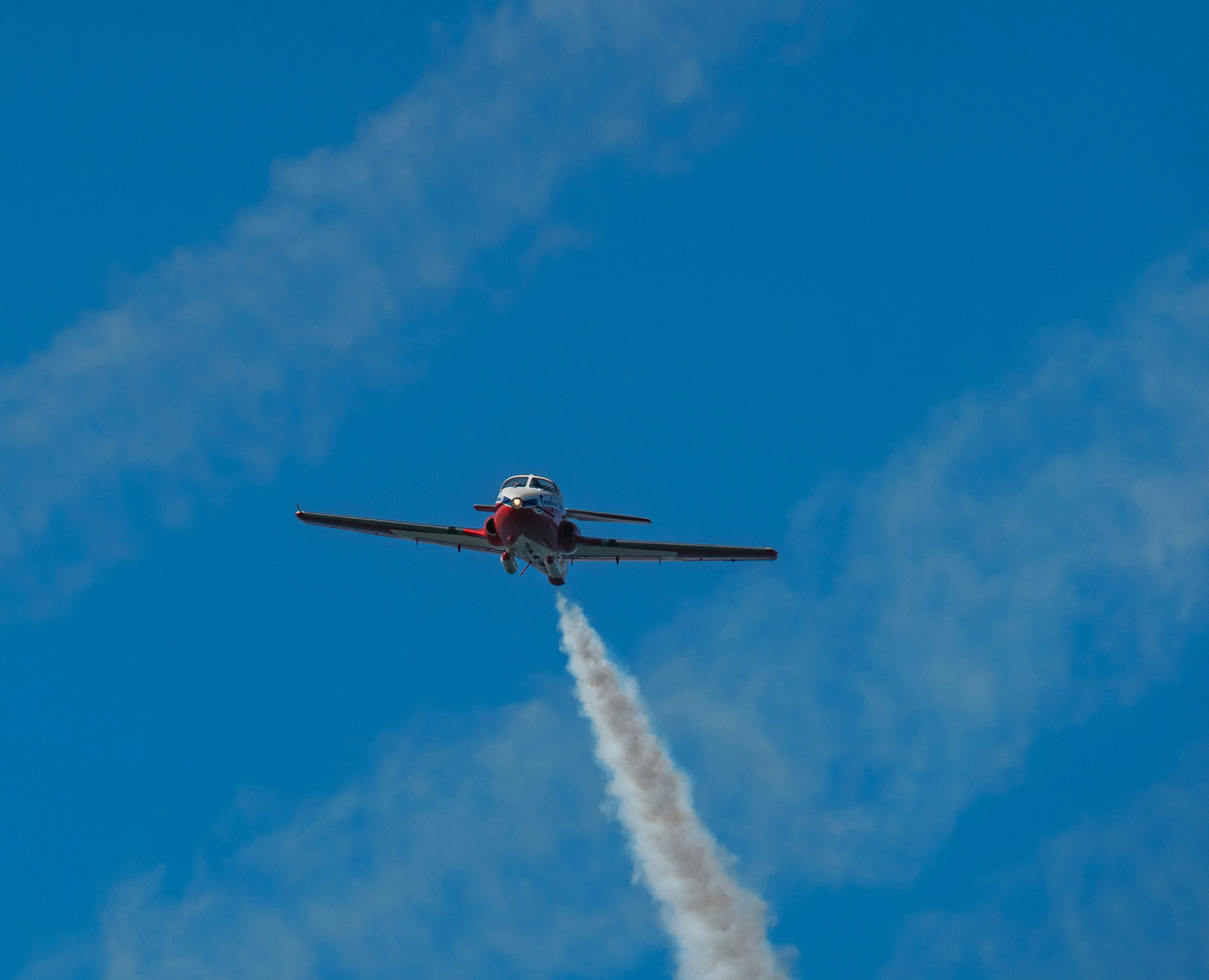 Small Red Airplane Flying with Vapor Trail · Free Stock Photo