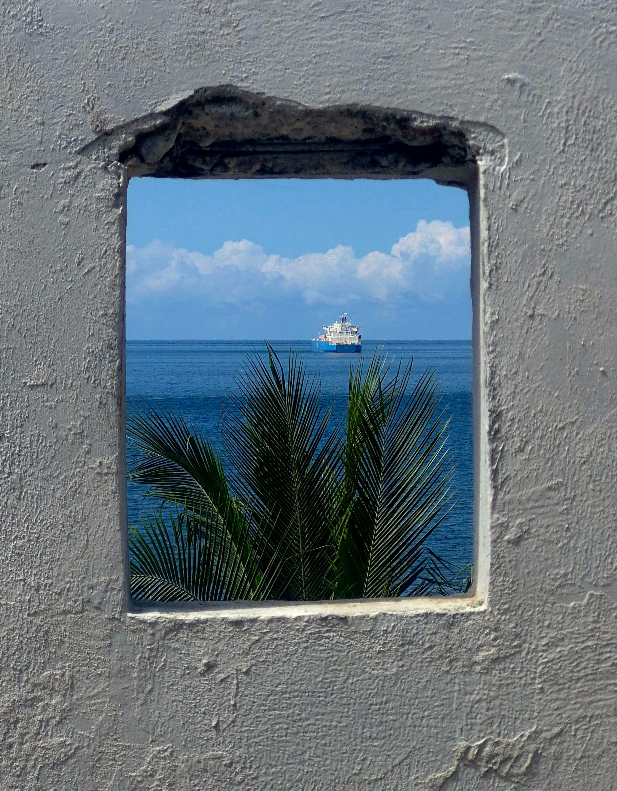 Ocean View Through Rustic Window with Ship · Free Stock Photo