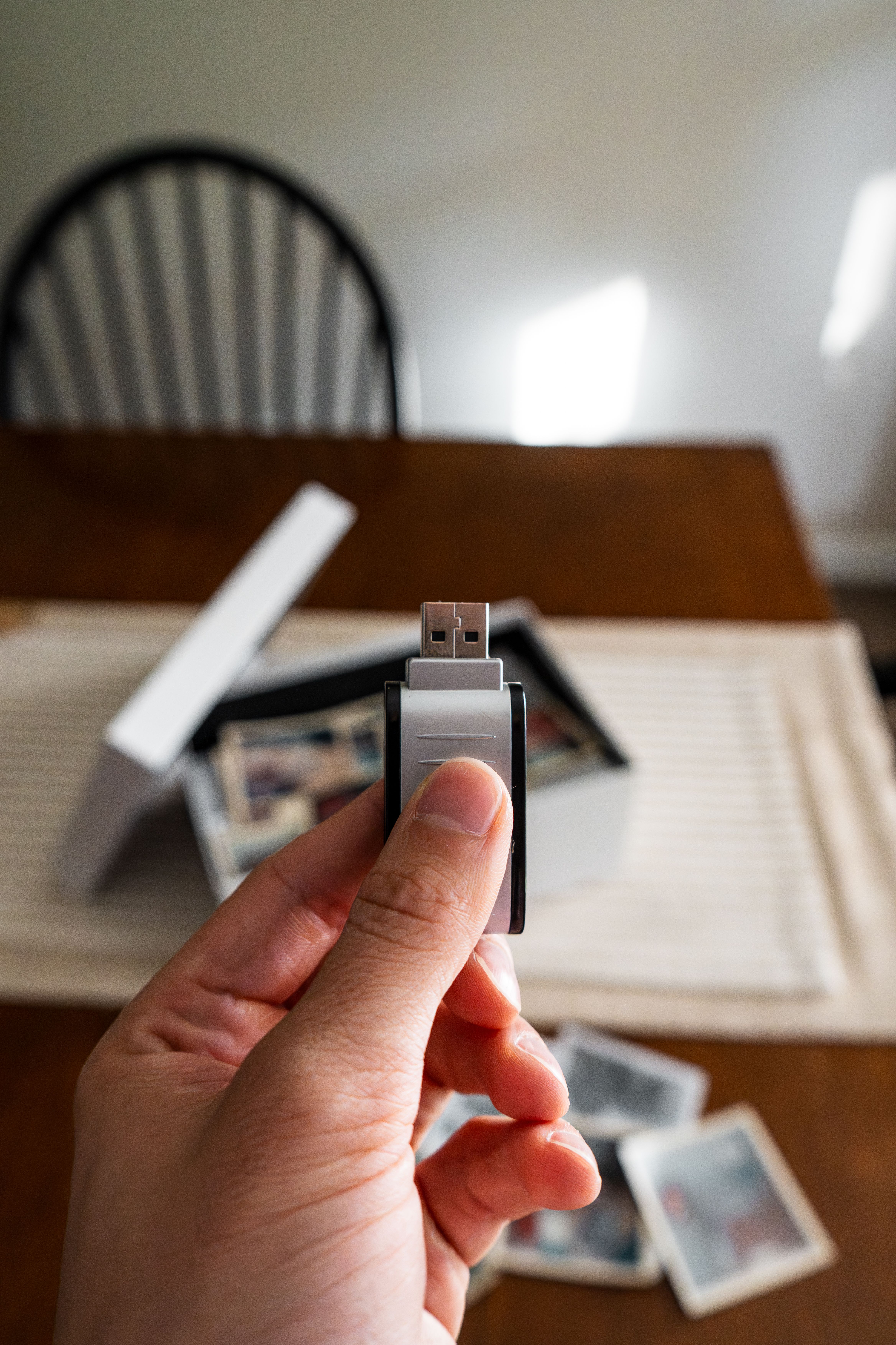 USB Drive and Vintage Photos on Table · Free Stock Photo