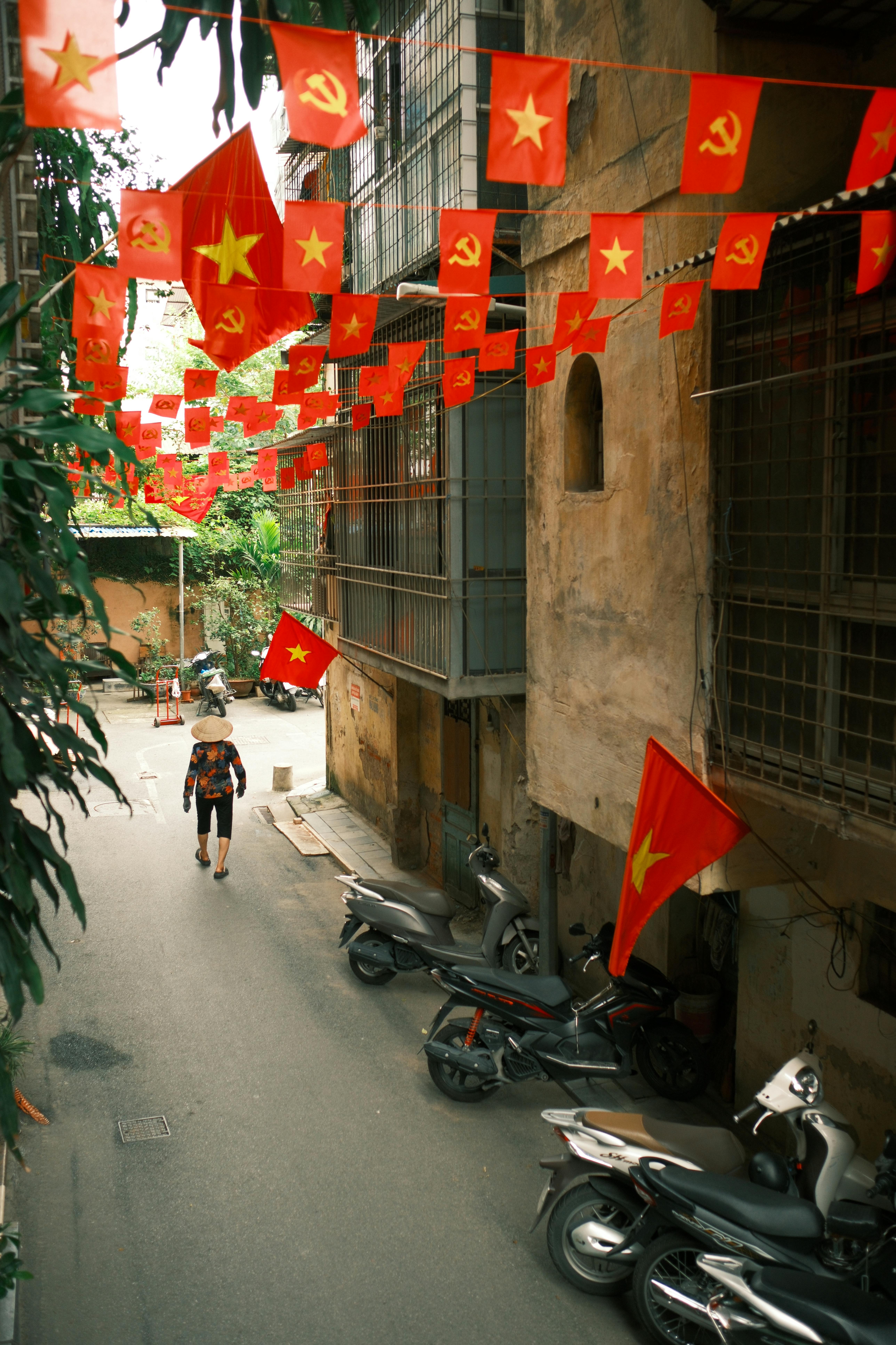 Street with Red Flags and Motorbikes in Hanoi · Free Stock Photo