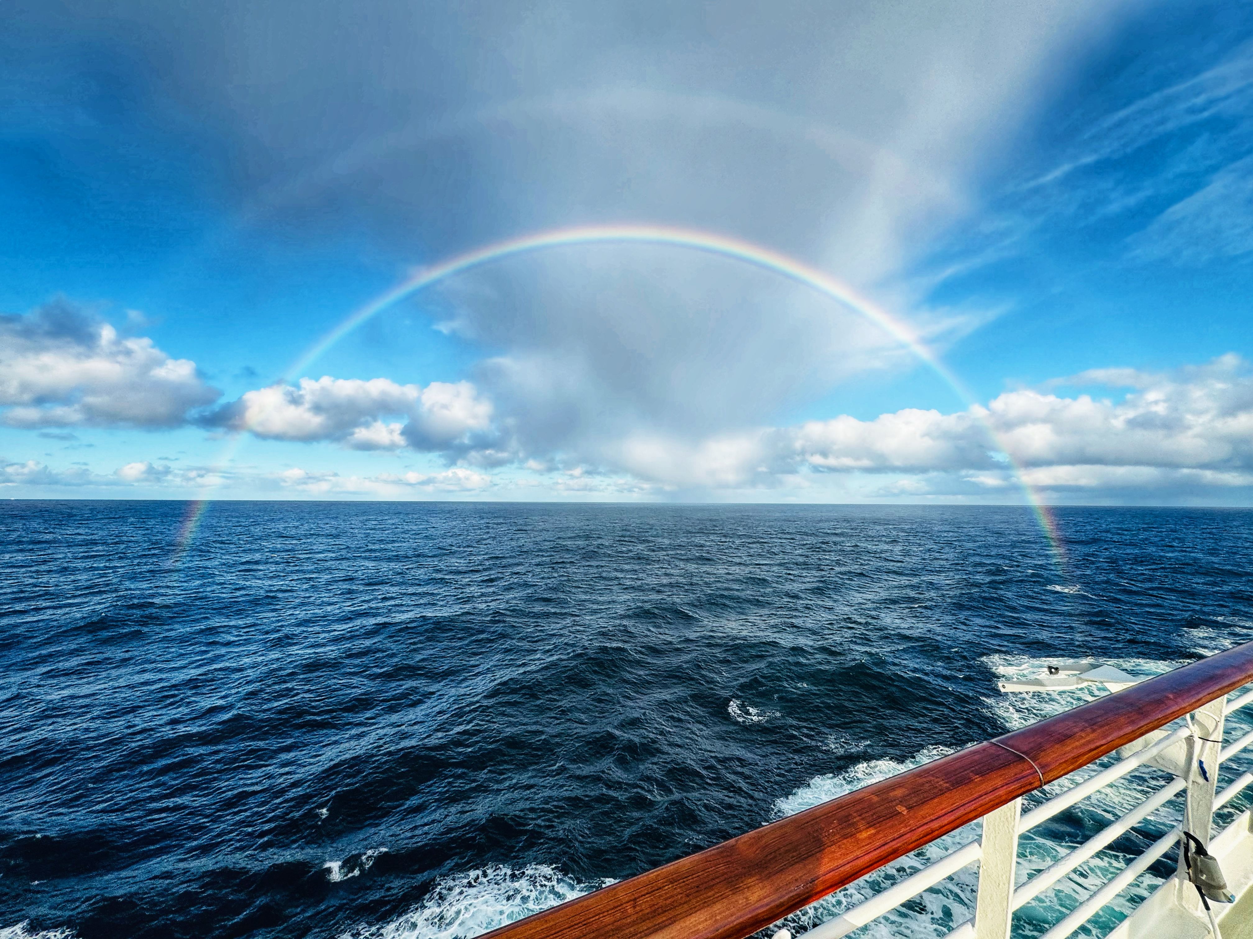 Vibrant Rainbow Over the Ocean from a Ship · Free Stock Photo