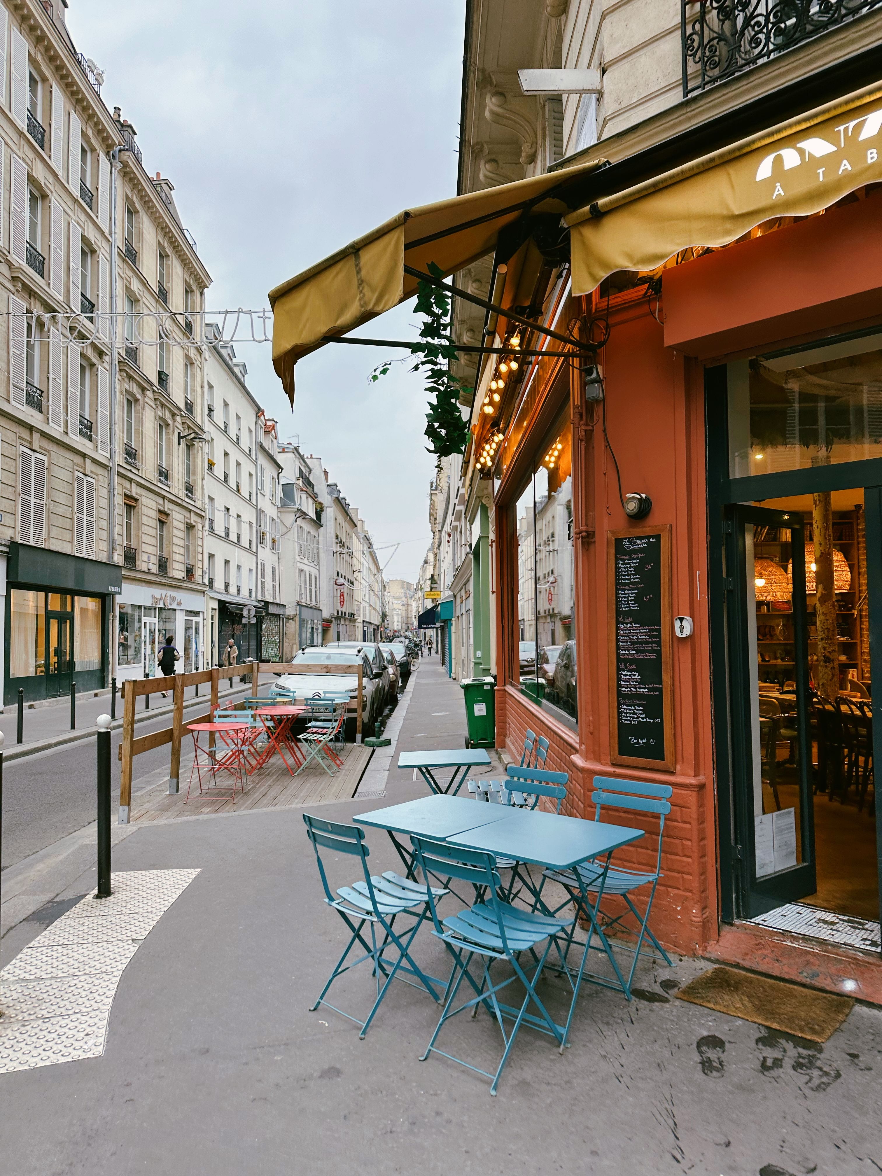 Quaint Parisian Cafe Street View in Summer · Free Stock Photo