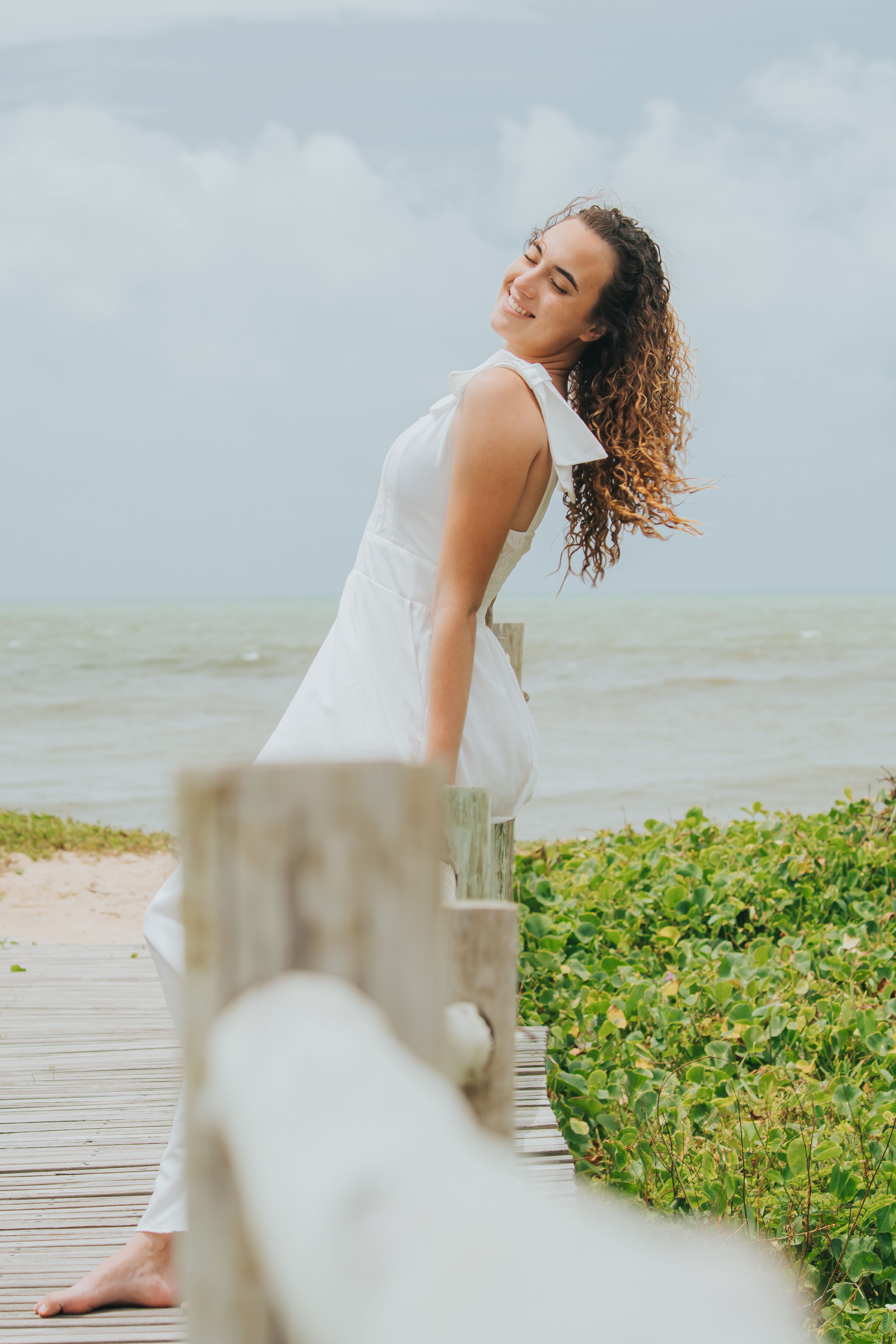 Photo of a Woman Looking Back while Walking on the Beach · Free Stock Photo