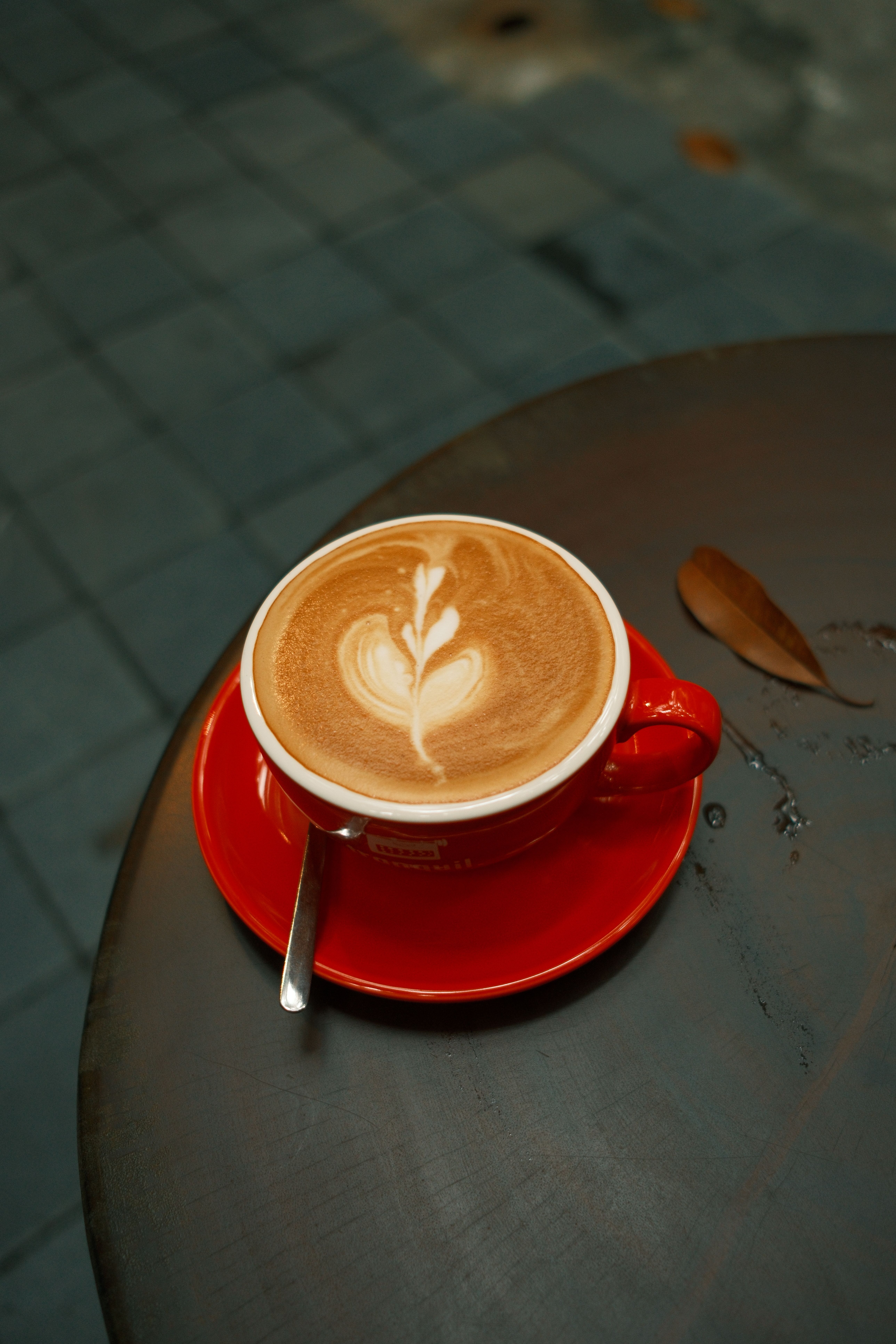Delicious Latte Art in Red Cup Outdoors · Free Stock Photo