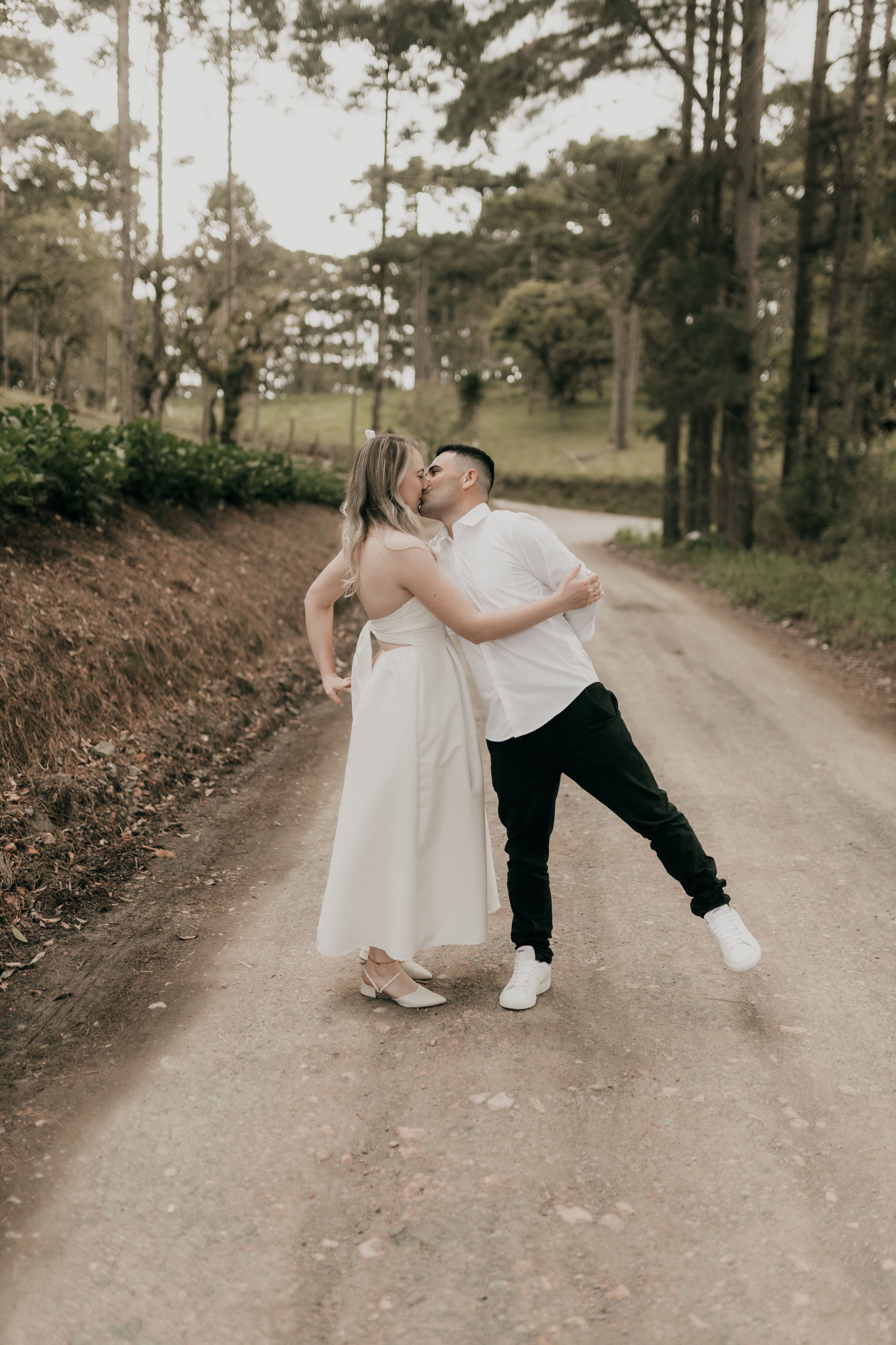 Romantic Couple Kiss on a Scenic Forest Path · Free Stock Photo