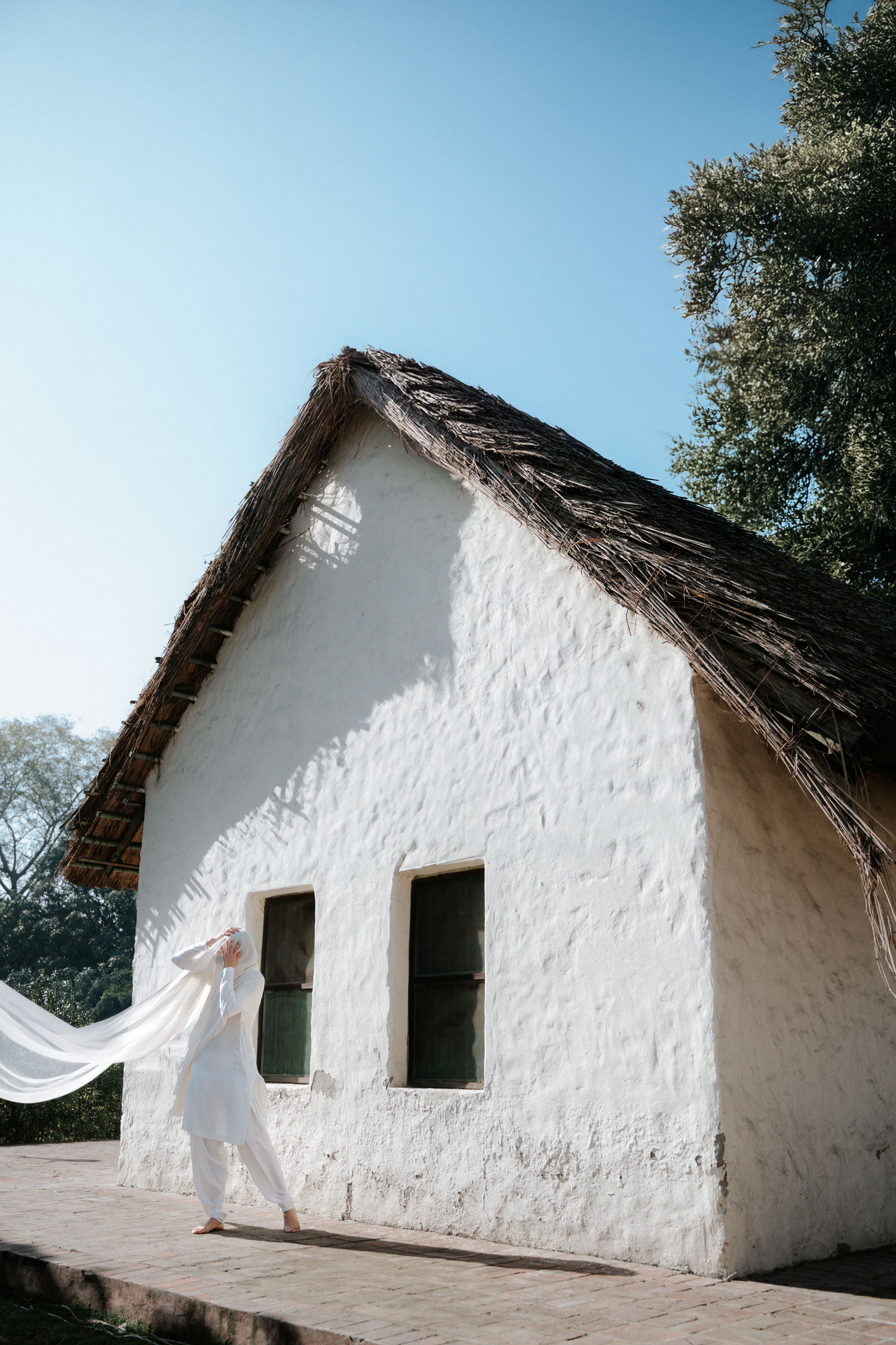 Traditional Rural Cottage with Woven Roof · Free Stock Photo