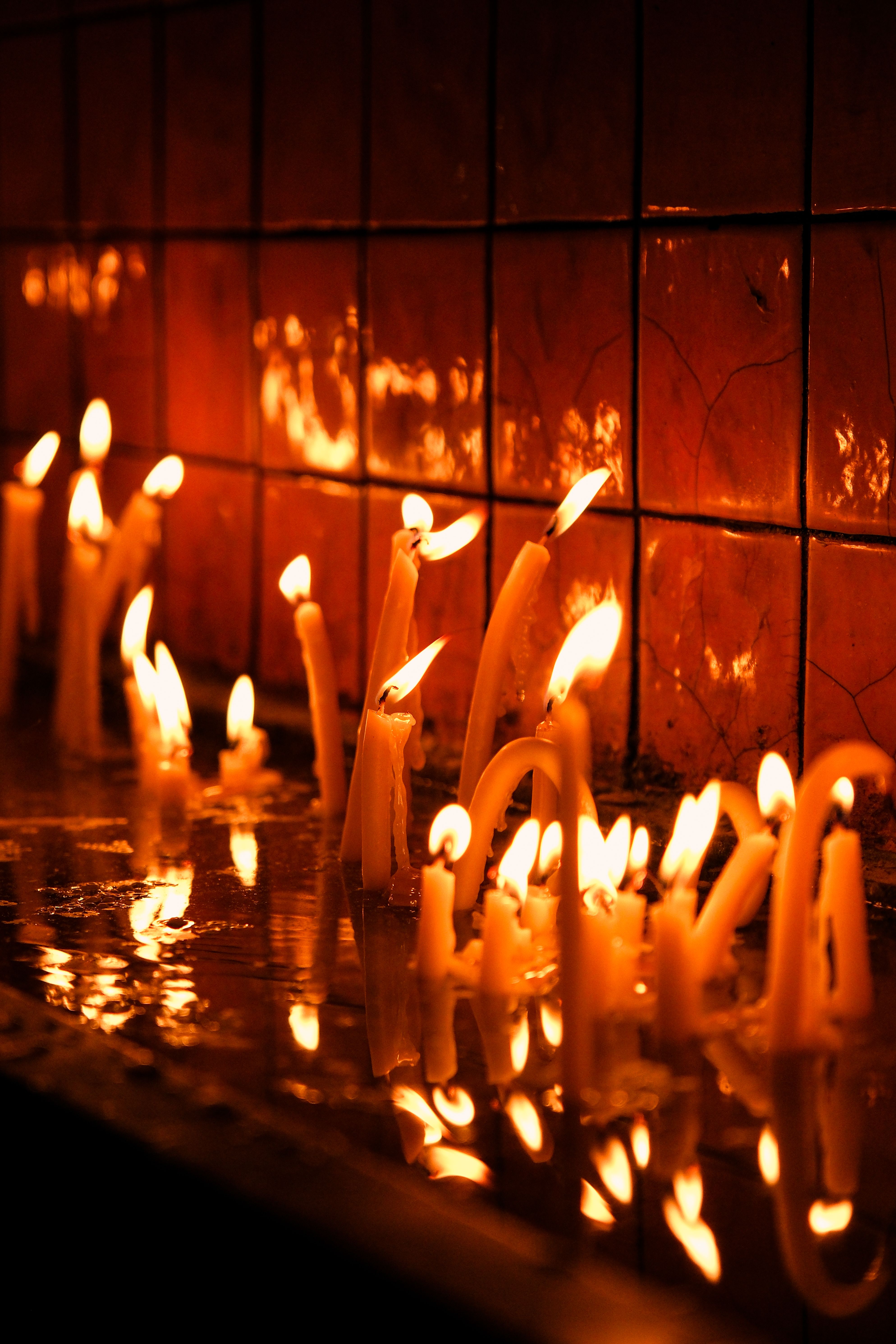 Atmospheric Candlelight Reflection on Wet Surface · Free Stock Photo