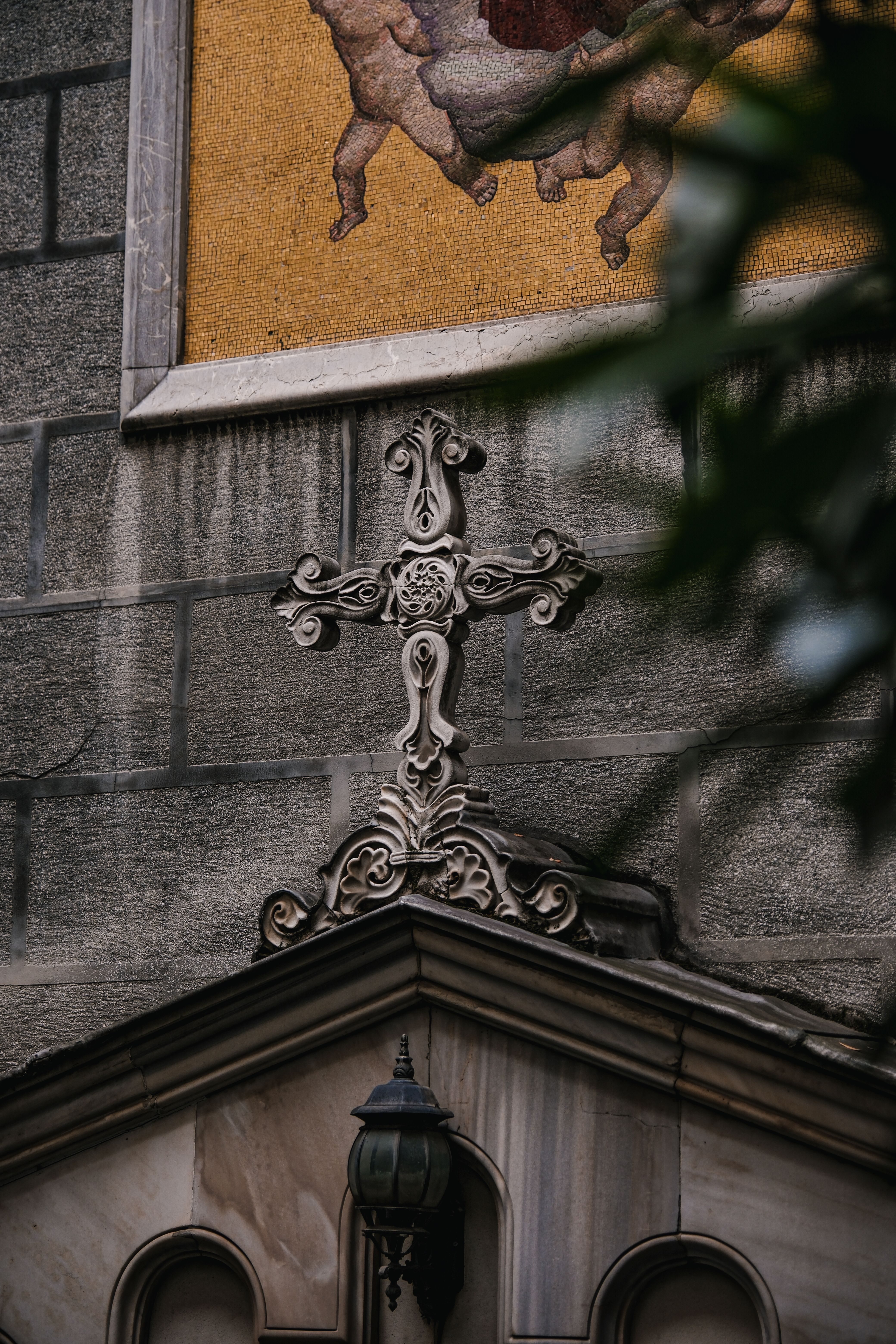 Ornate Stone Cross on Church Facade · Free Stock Photo