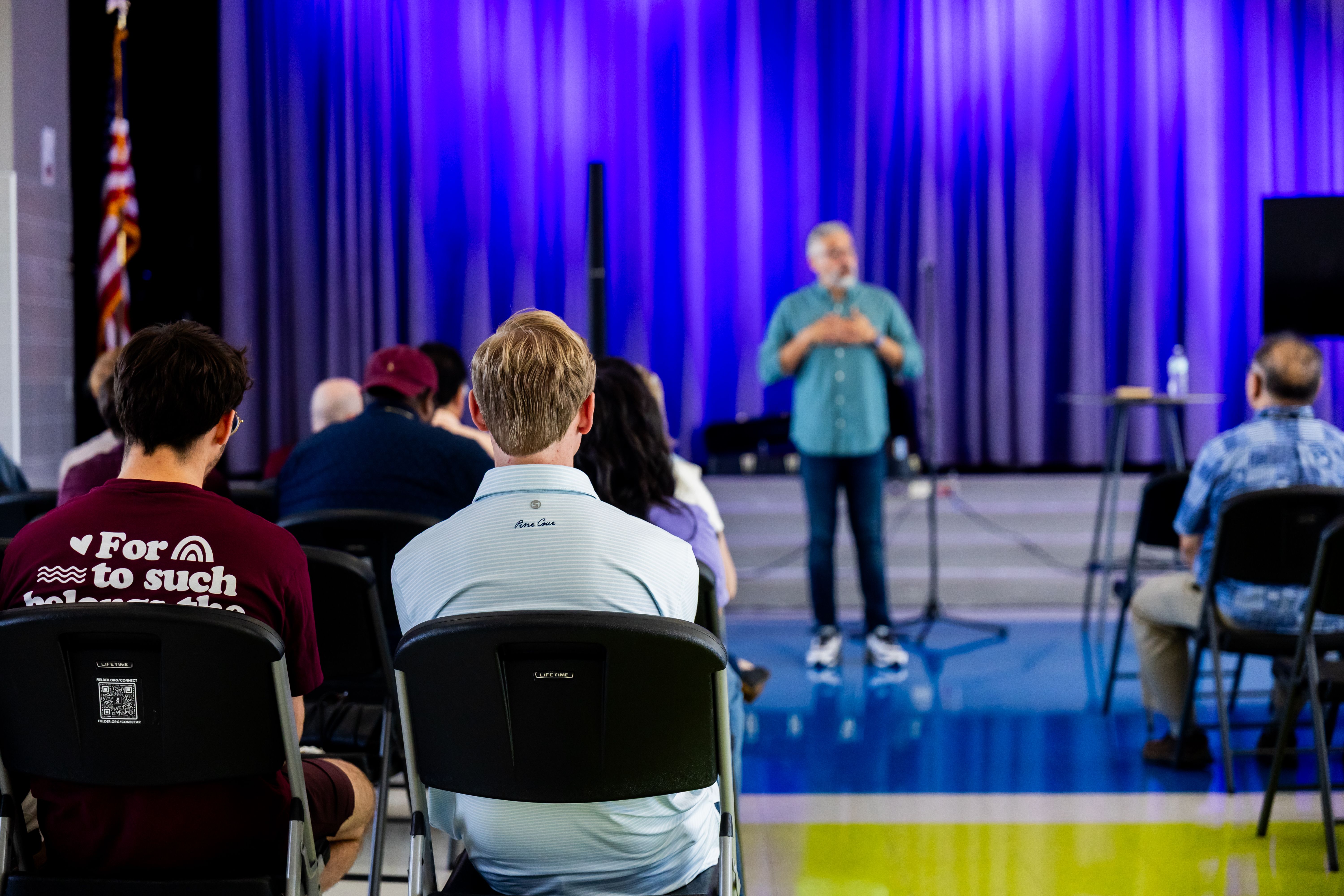 Diverse Audience Engaged in Indoor Lecture · Free Stock Photo