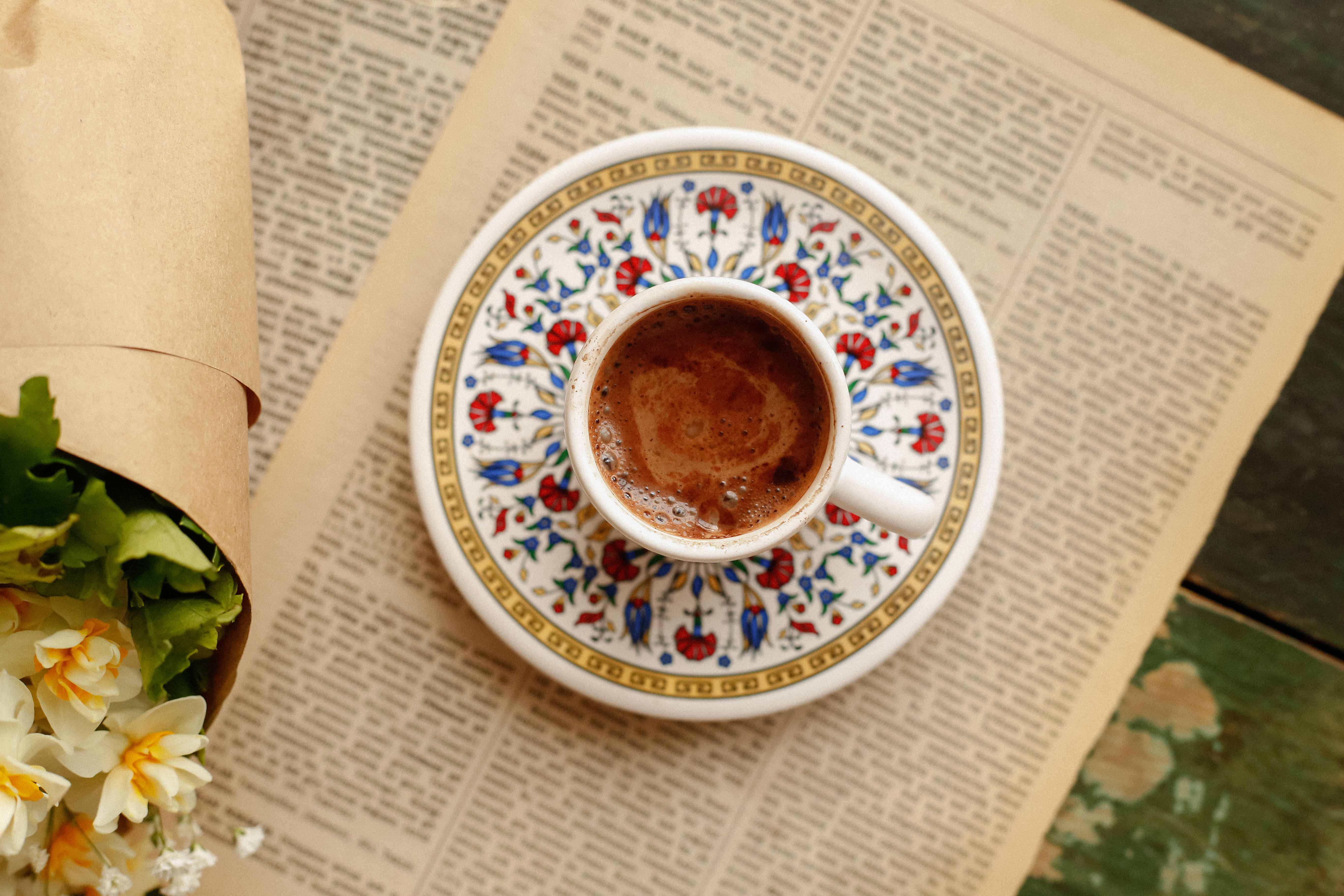 Charming Coffee Cup on Vintage Newspaper · Free Stock Photo