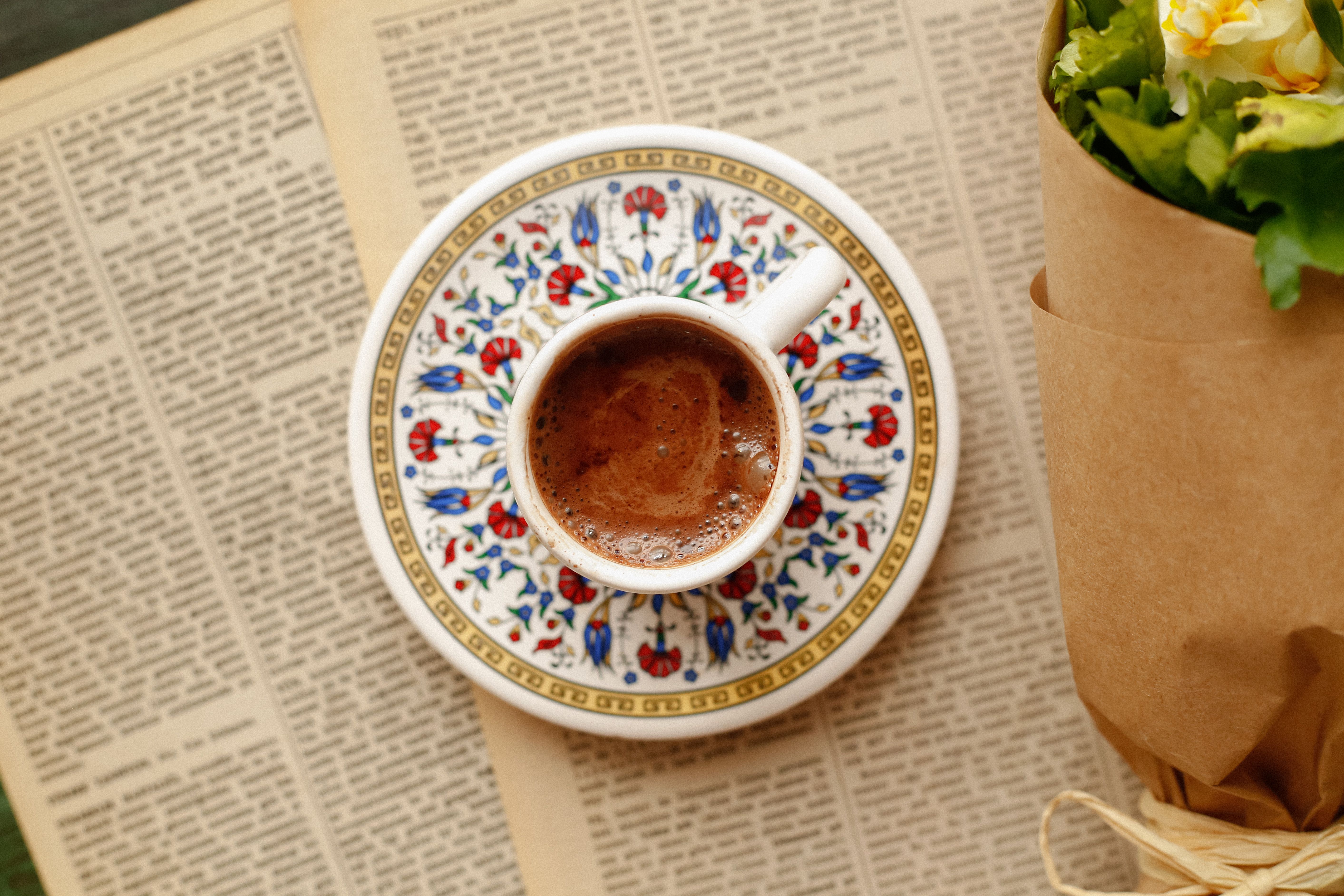 Artistic Coffee with Flowers on Vintage Newspaper · Free Stock Photo
