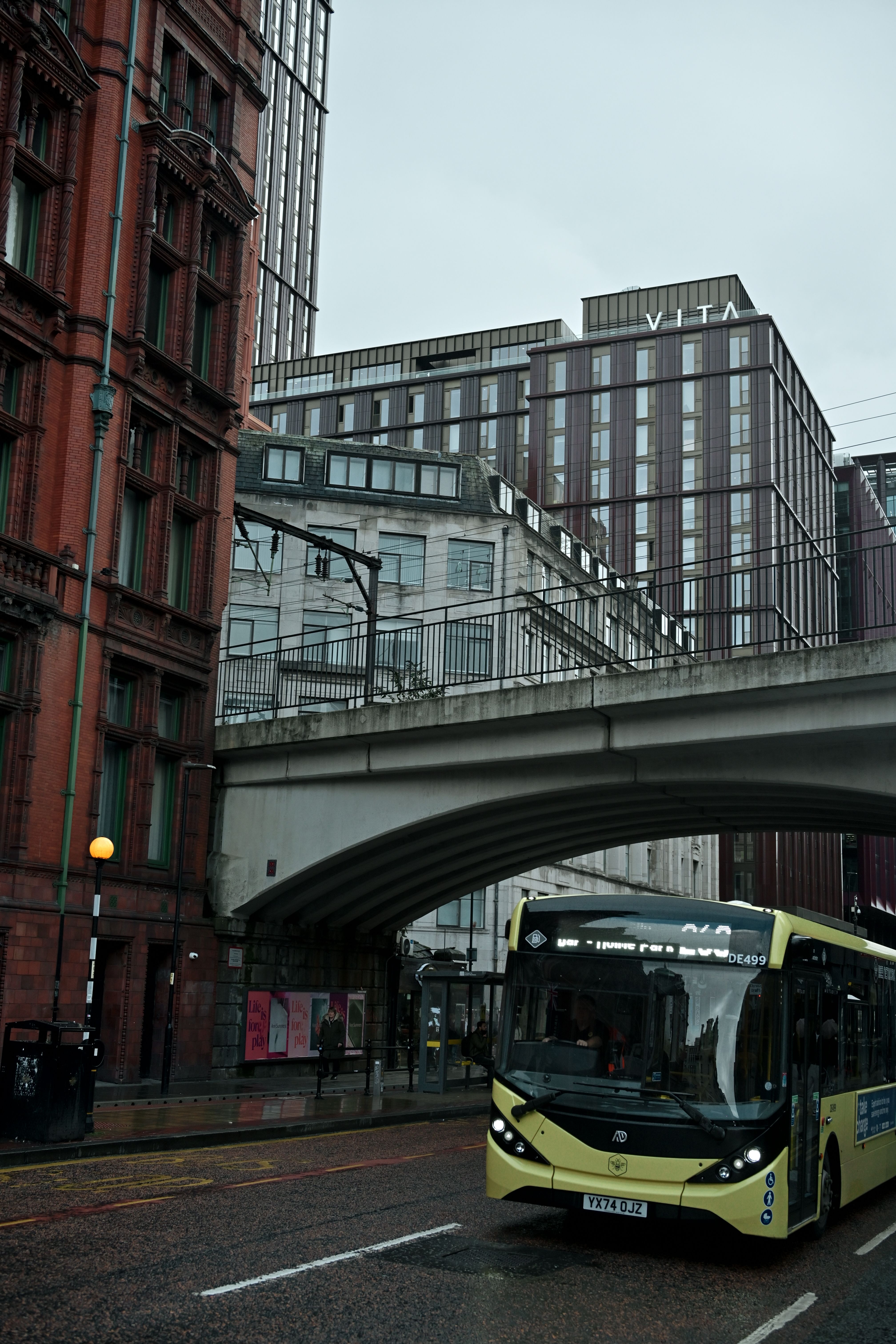 Urban Scene with Public Bus Under Bridge · Free Stock Photo