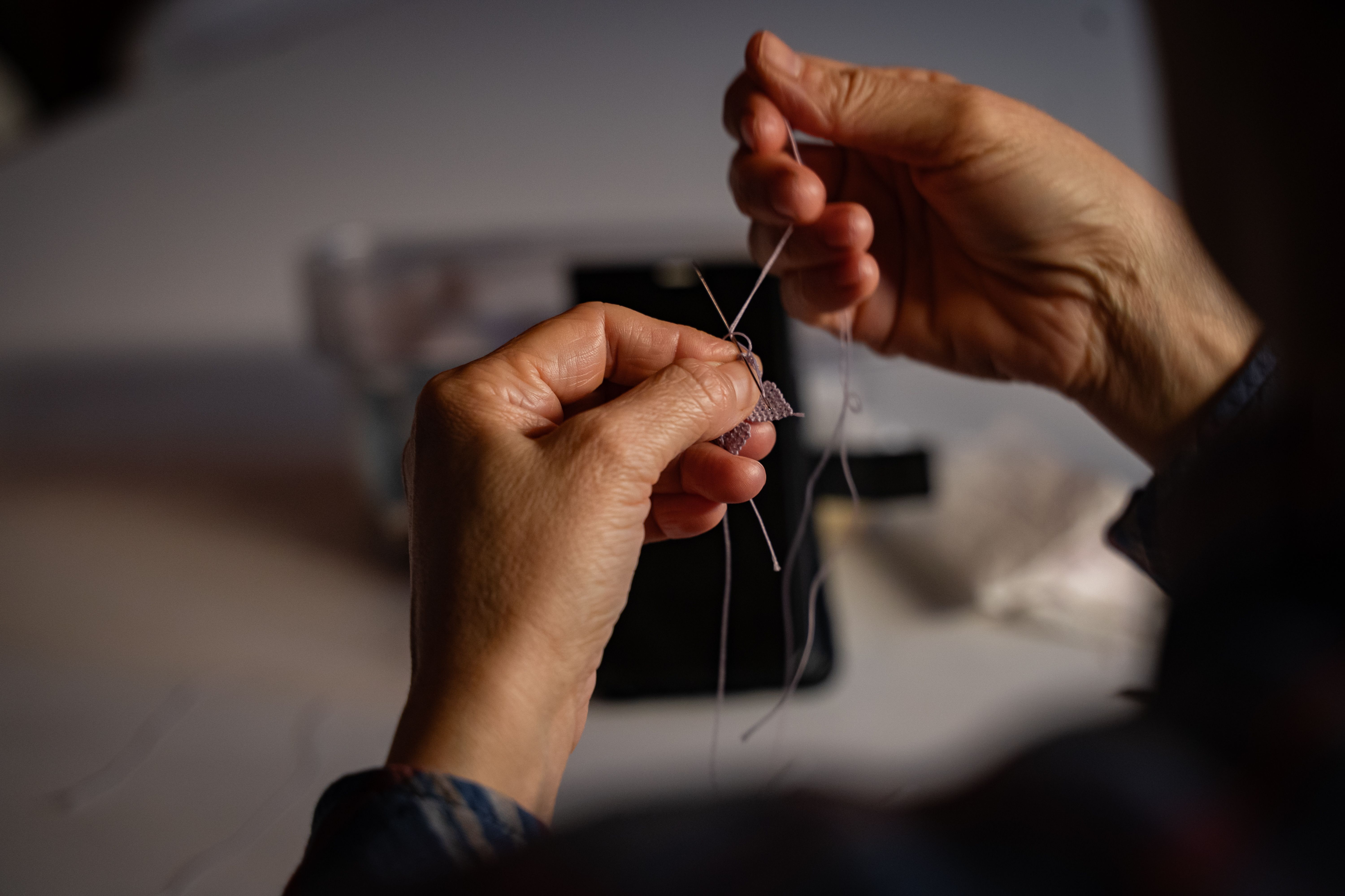 Close-up of Hands Sewing in Traditional Craft Workshop · Free Stock Photo