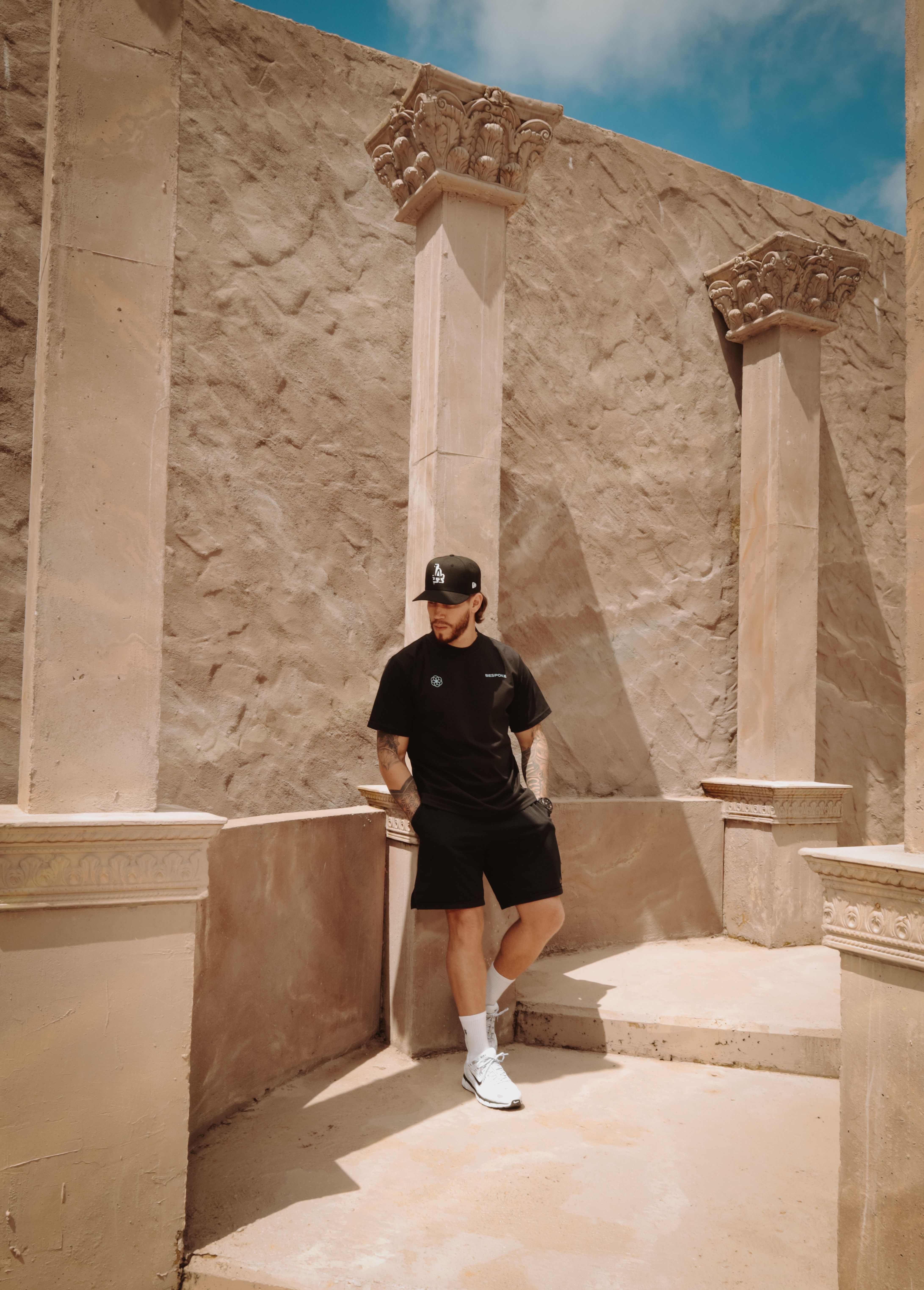 Young Man Standing by Ancient Style Columns · Free Stock Photo