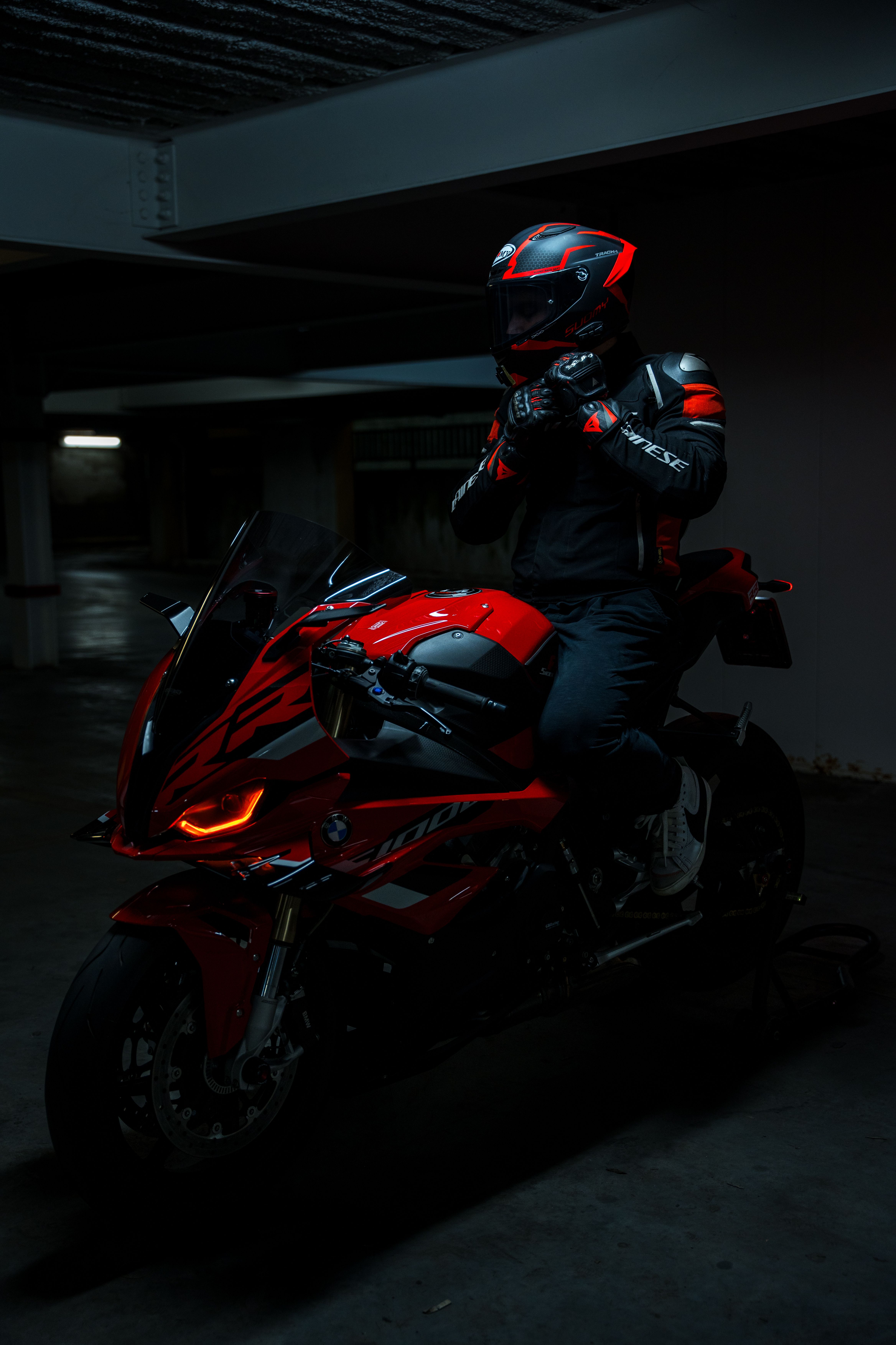 Red Sport Motorcycle Rider in Urban Garage · Free Stock Photo