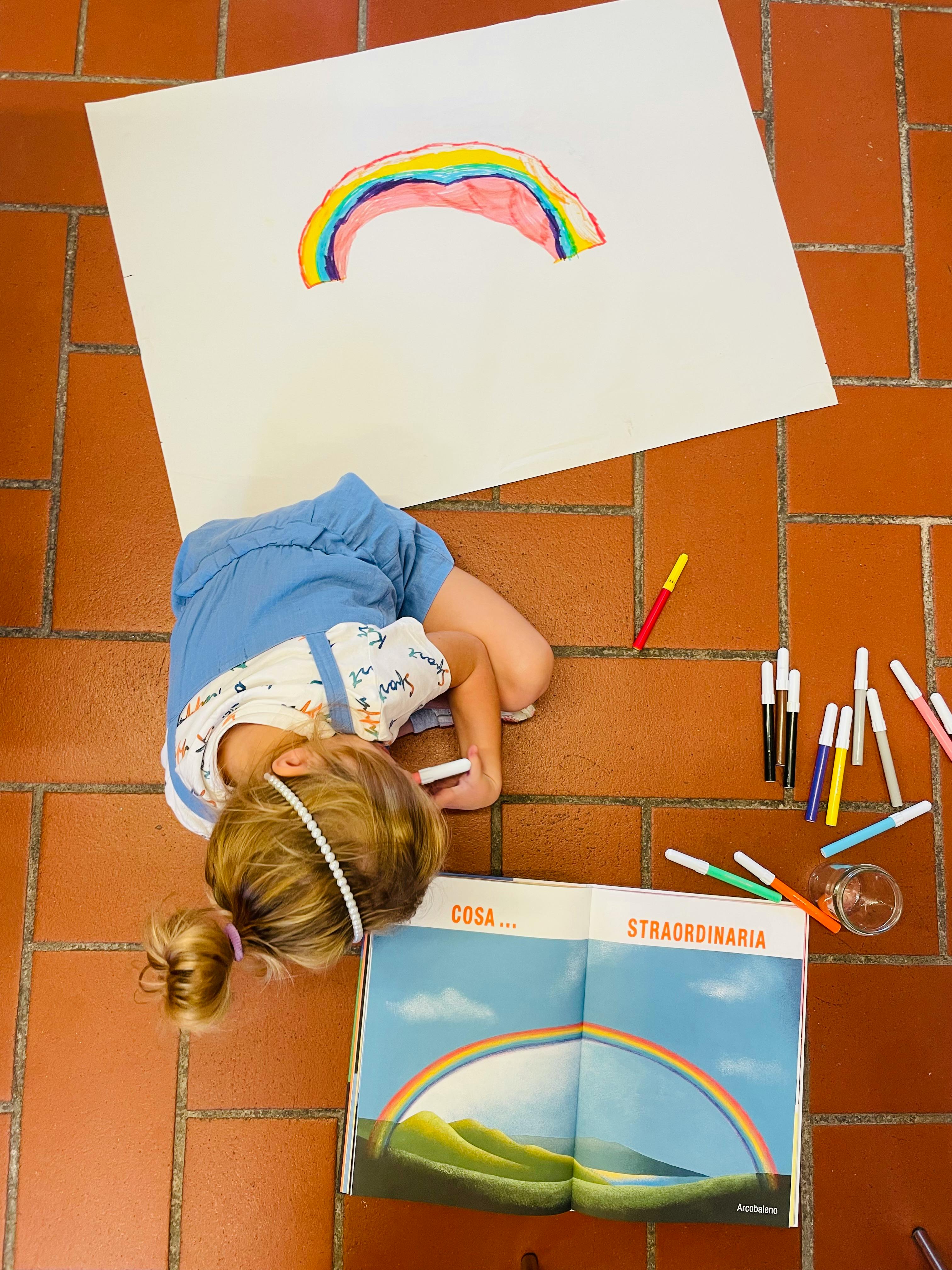 Child Drawing Rainbow on Floor with Markers · Free Stock Photo