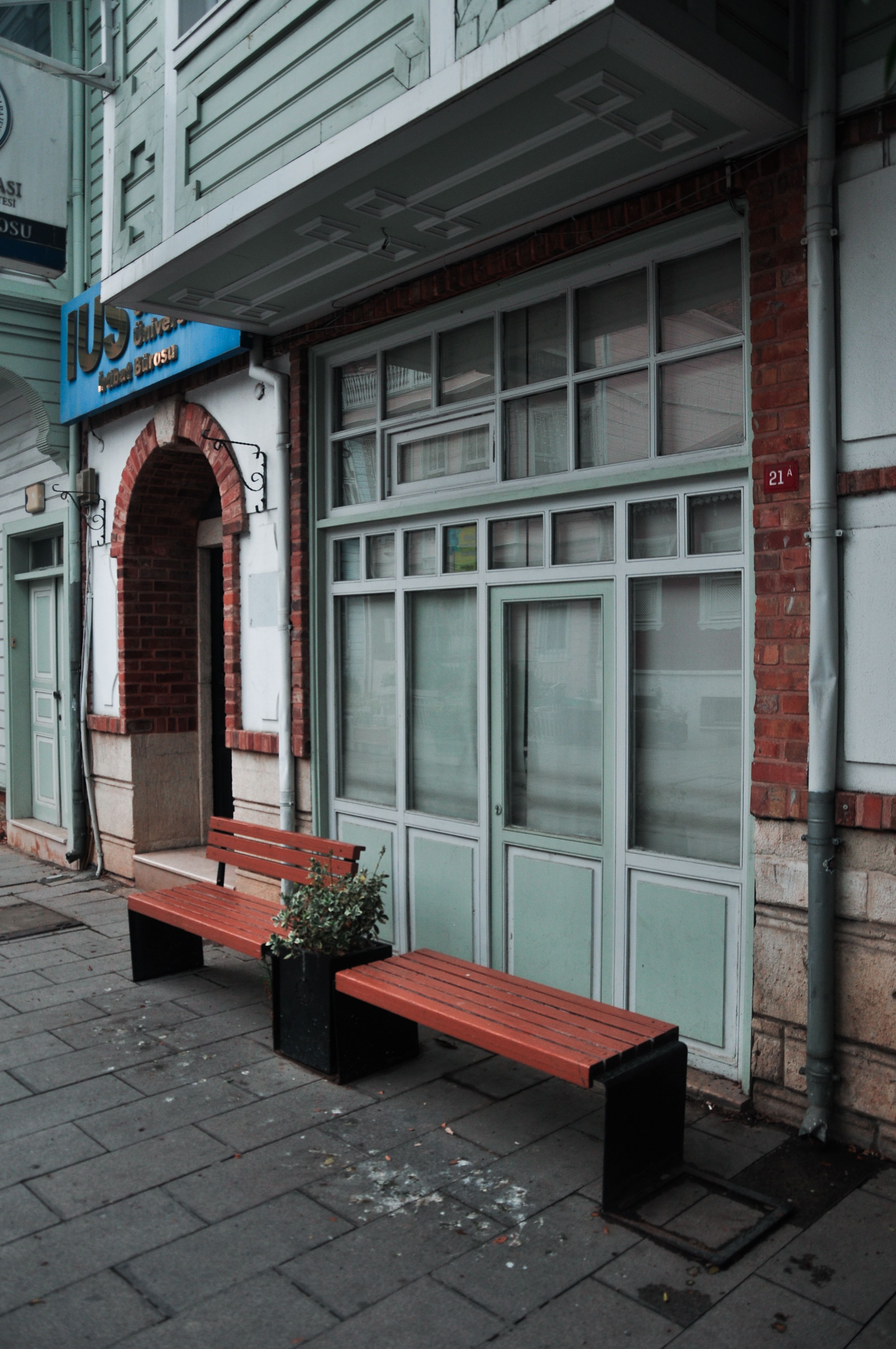 Urban Street Scene with Benches and Shopfront · Free Stock Photo