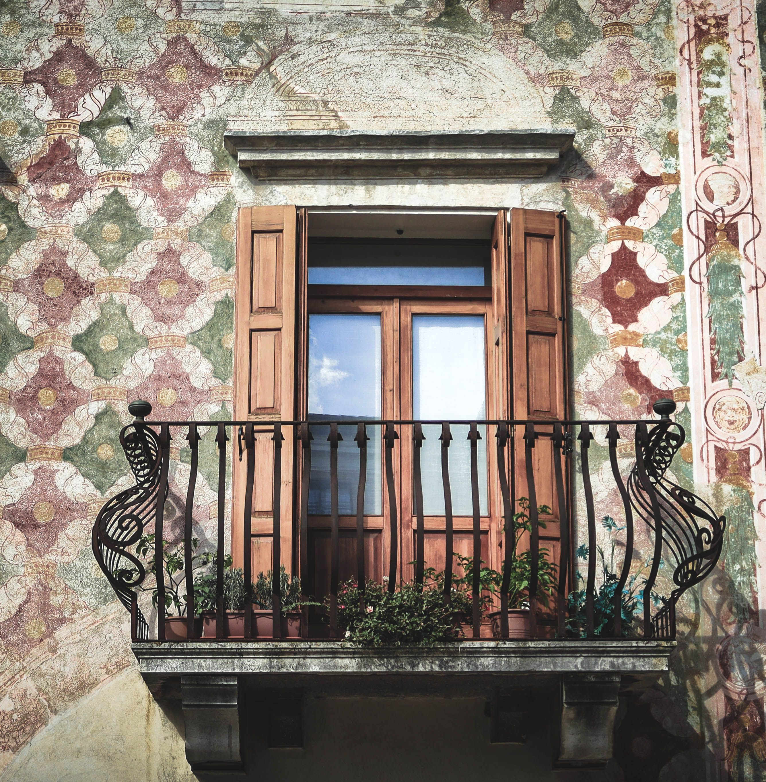 Decorative Balcony on Historic Painted Facade · Free Stock Photo