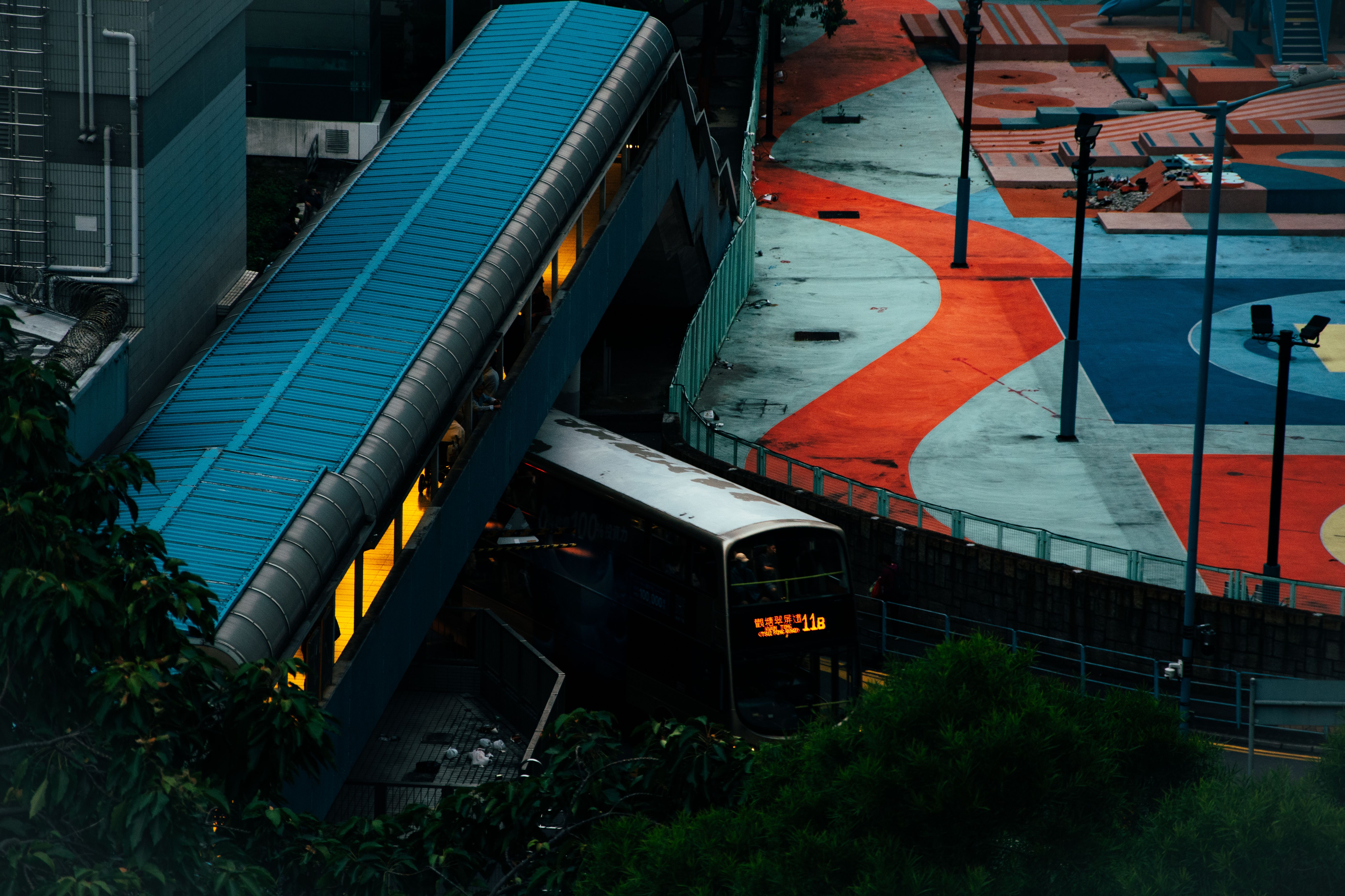 Urban bus station with colorful surroundings · Free Stock Photo