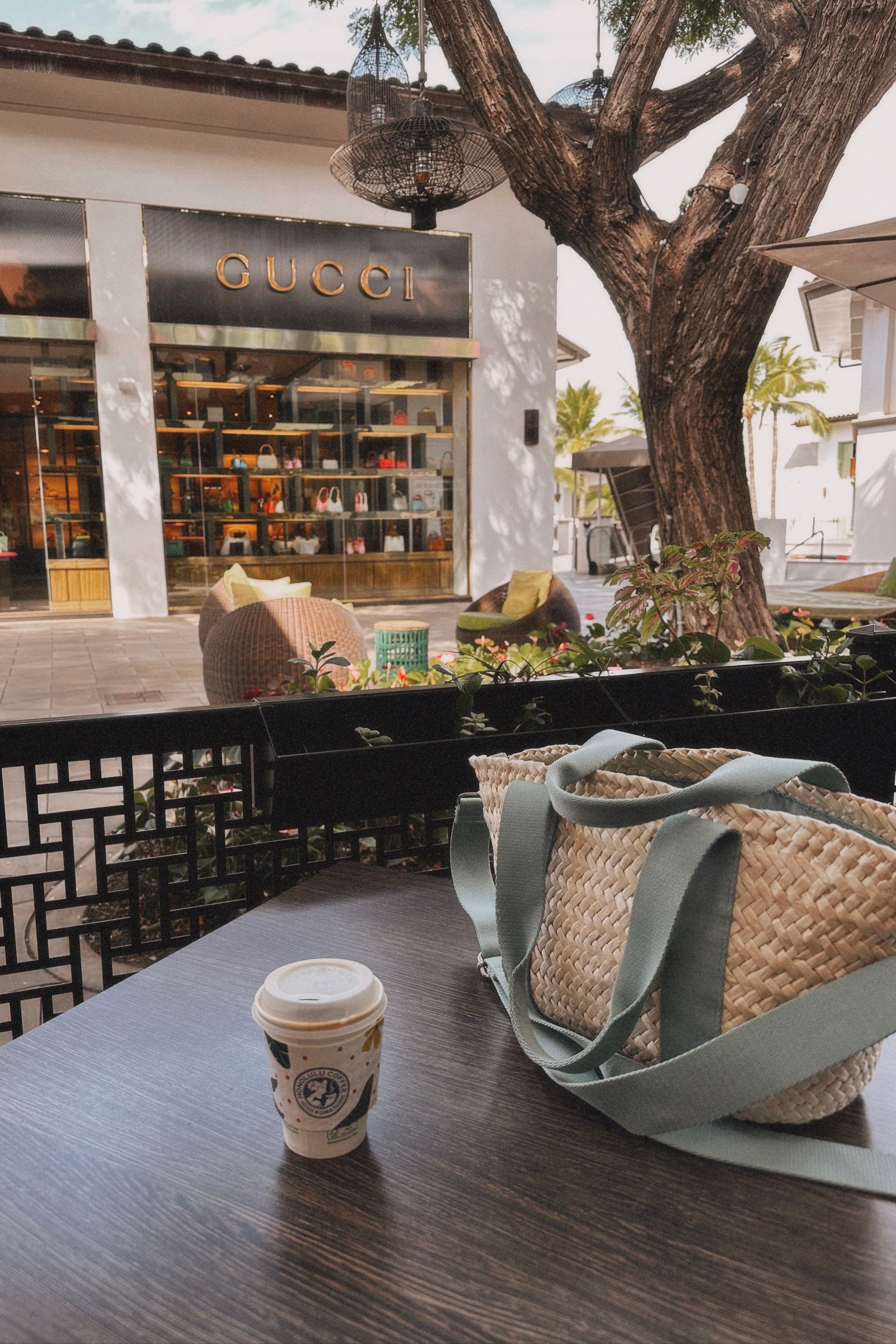 Outdoor Cafe Overlooking Gucci Storefront · Free Stock Photo